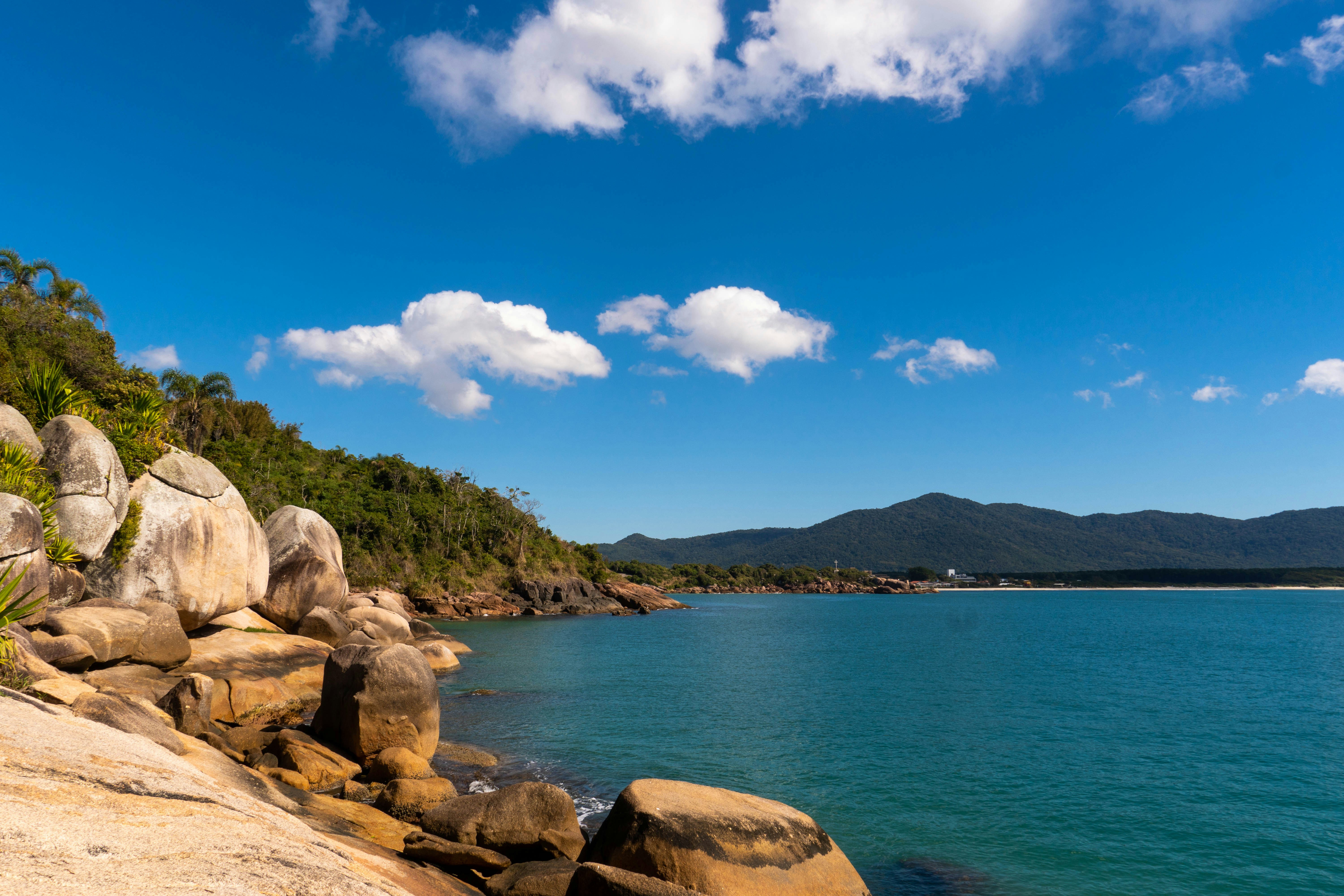 Costa rocosa con océano azul y colinas verdes foto – Imagen de Montaña ...