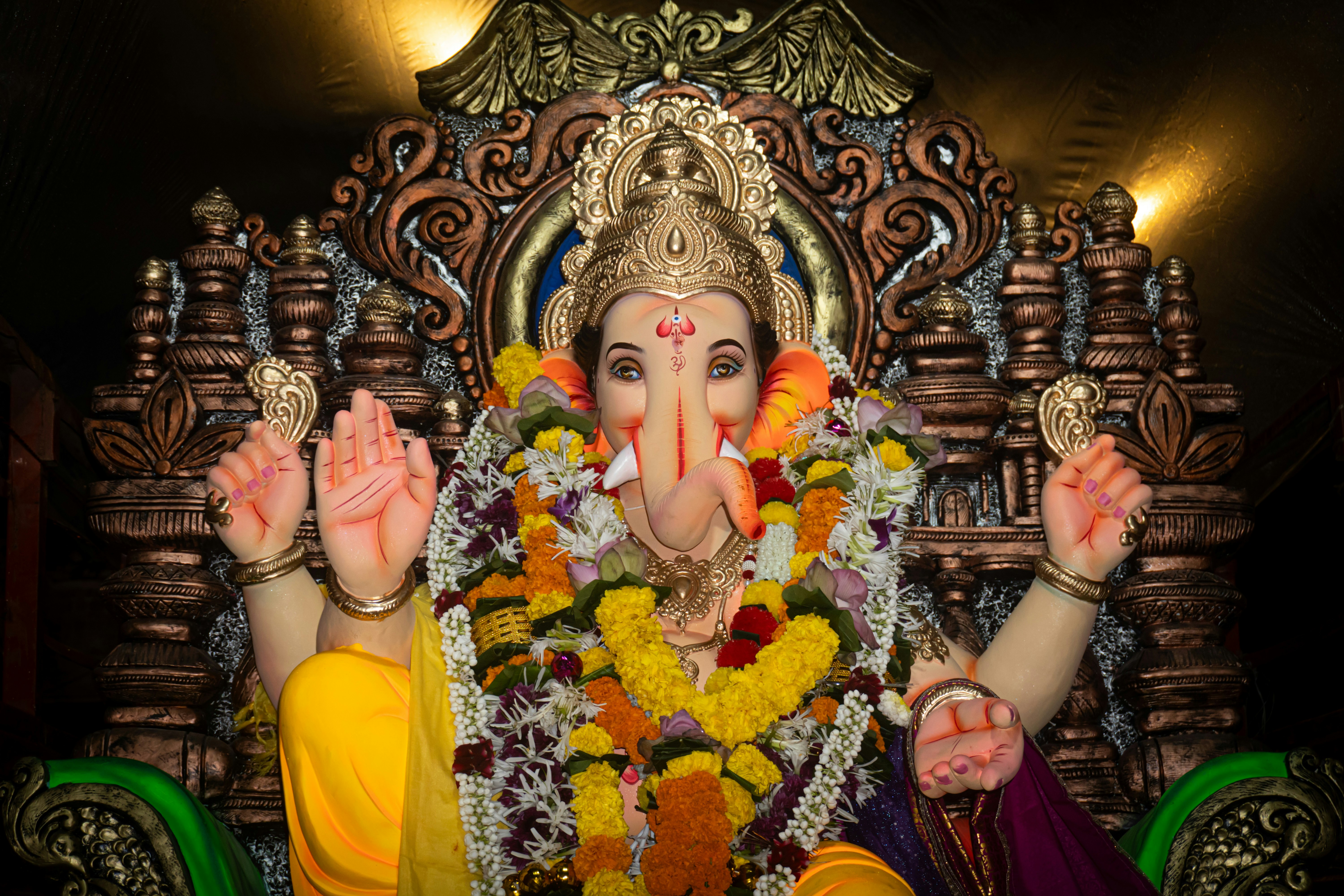 Ganesha statue adorned with garlands and jewelry
