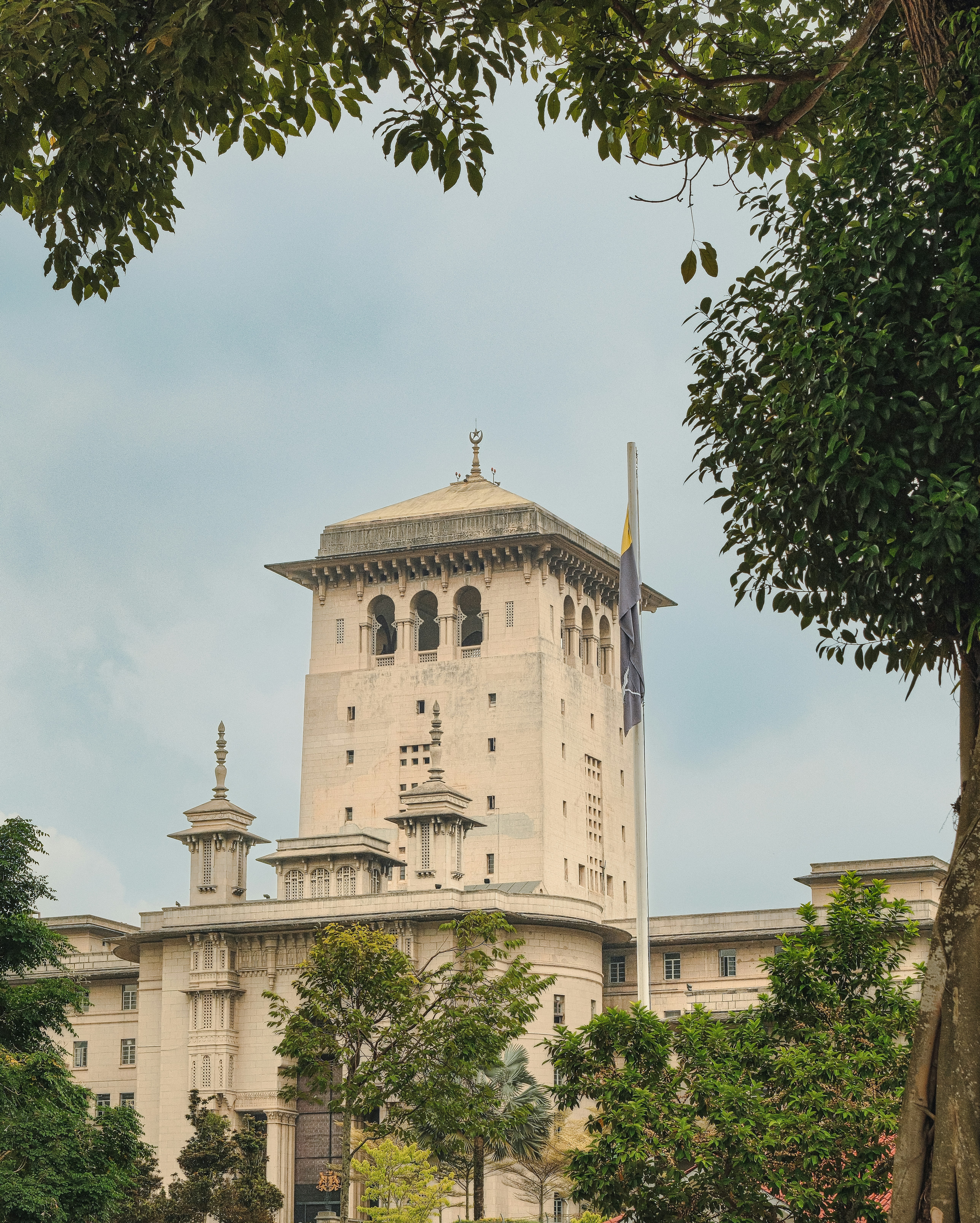 Ornate building with towers and trees framing view photo – Free ...