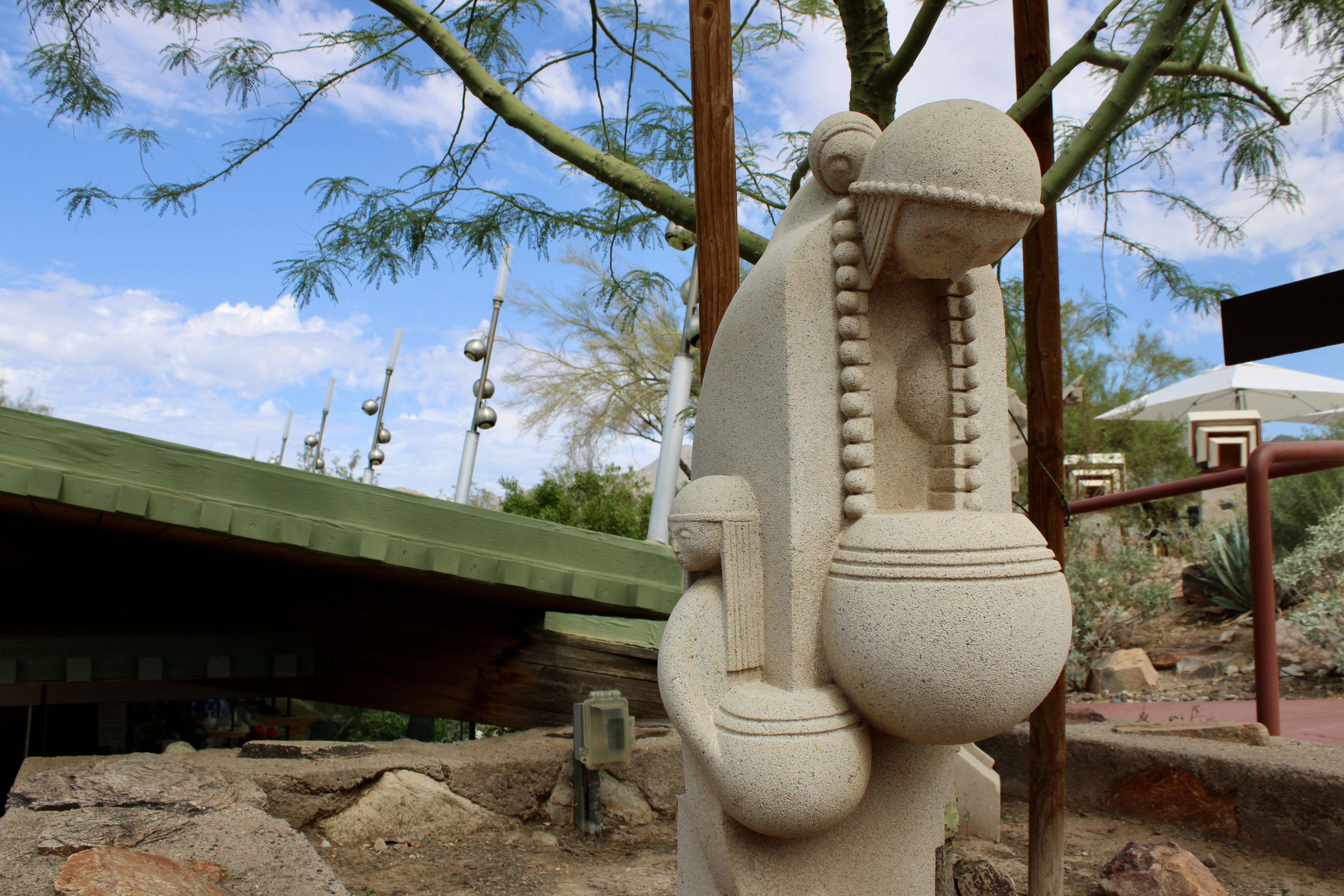 Stone Sentinel in a Desert Garden Under a Bright Blue Sky