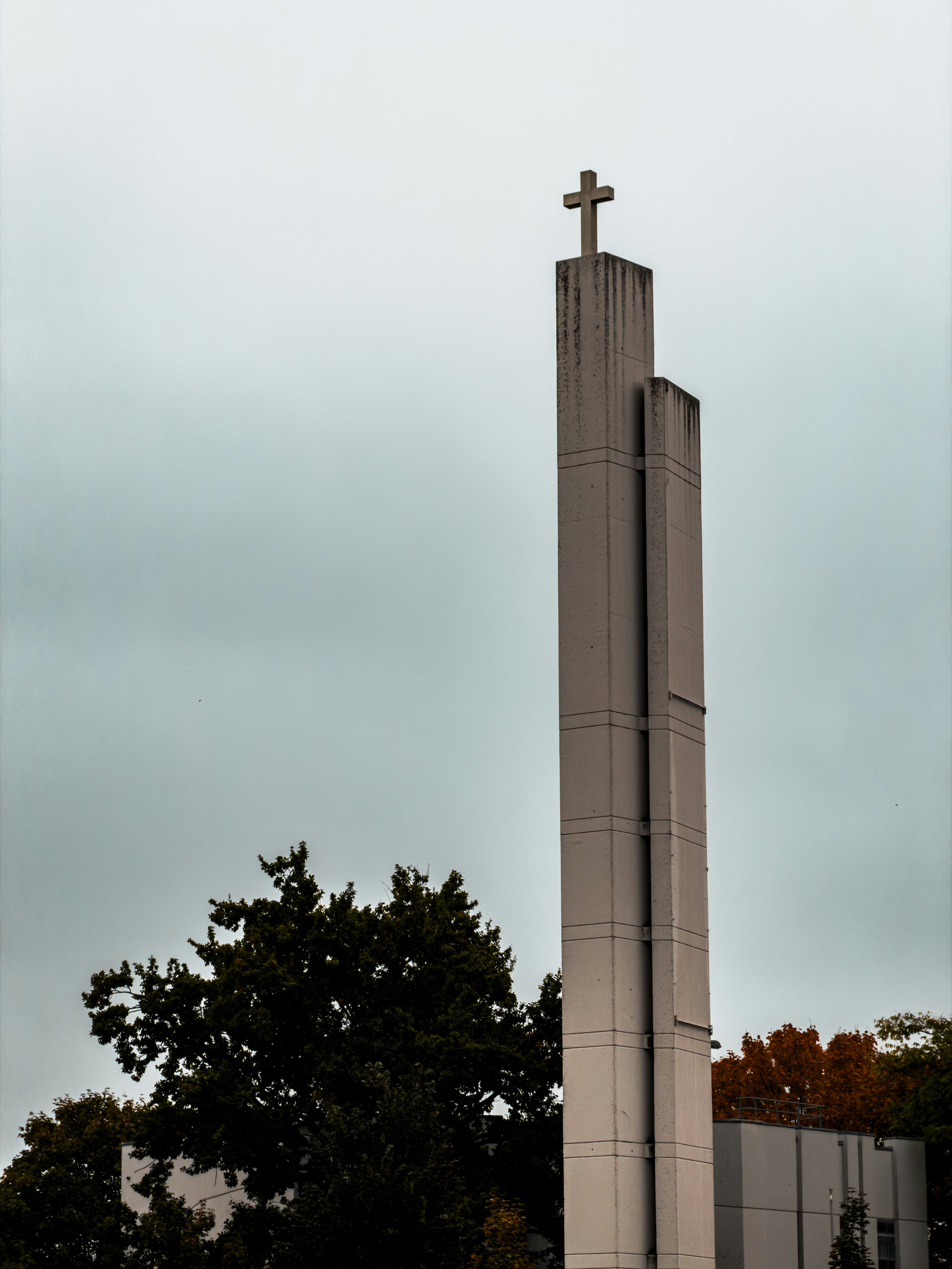 Silent Sentinel: The Cross Amidst Autumn's Embrace