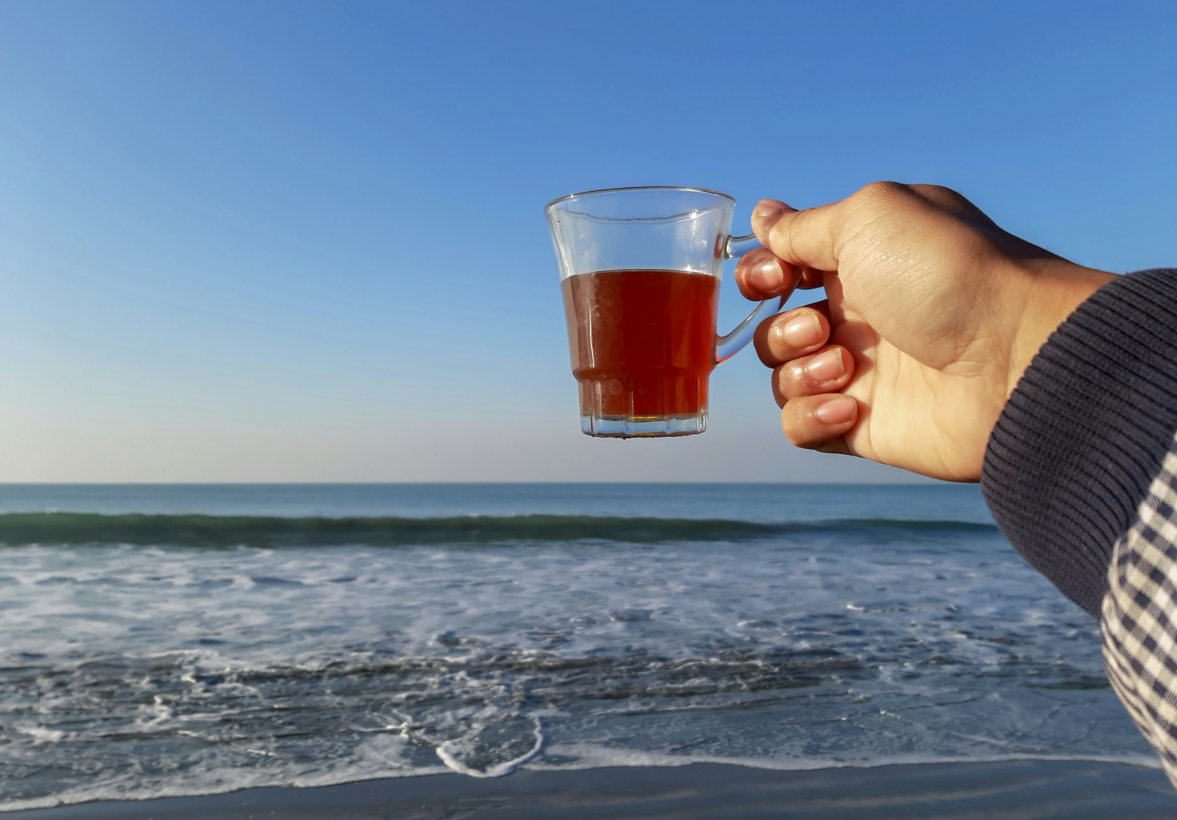 Sipping Serenity: A Moment by the Shore