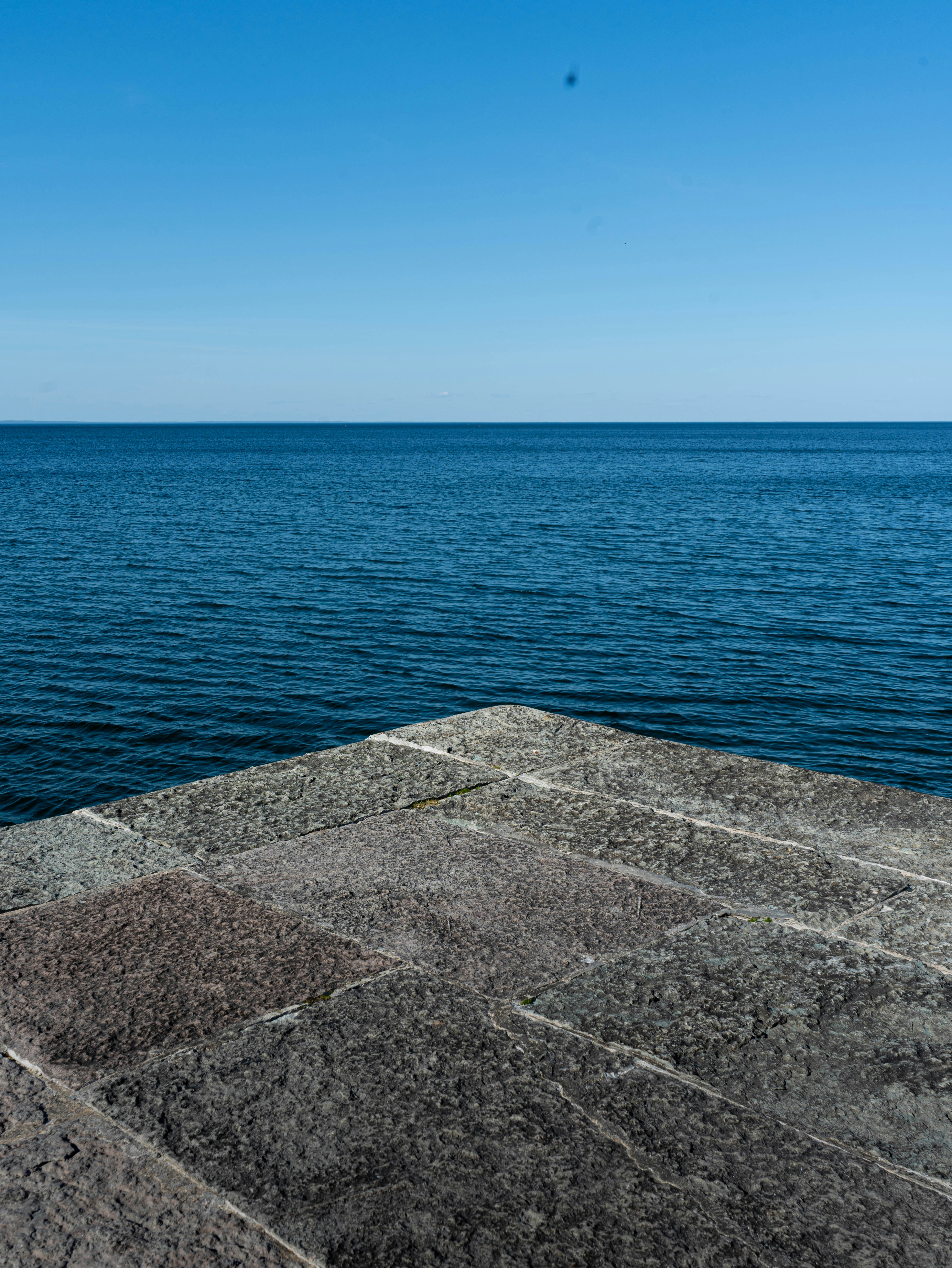 Stone walkway leading to the deep blue ocean