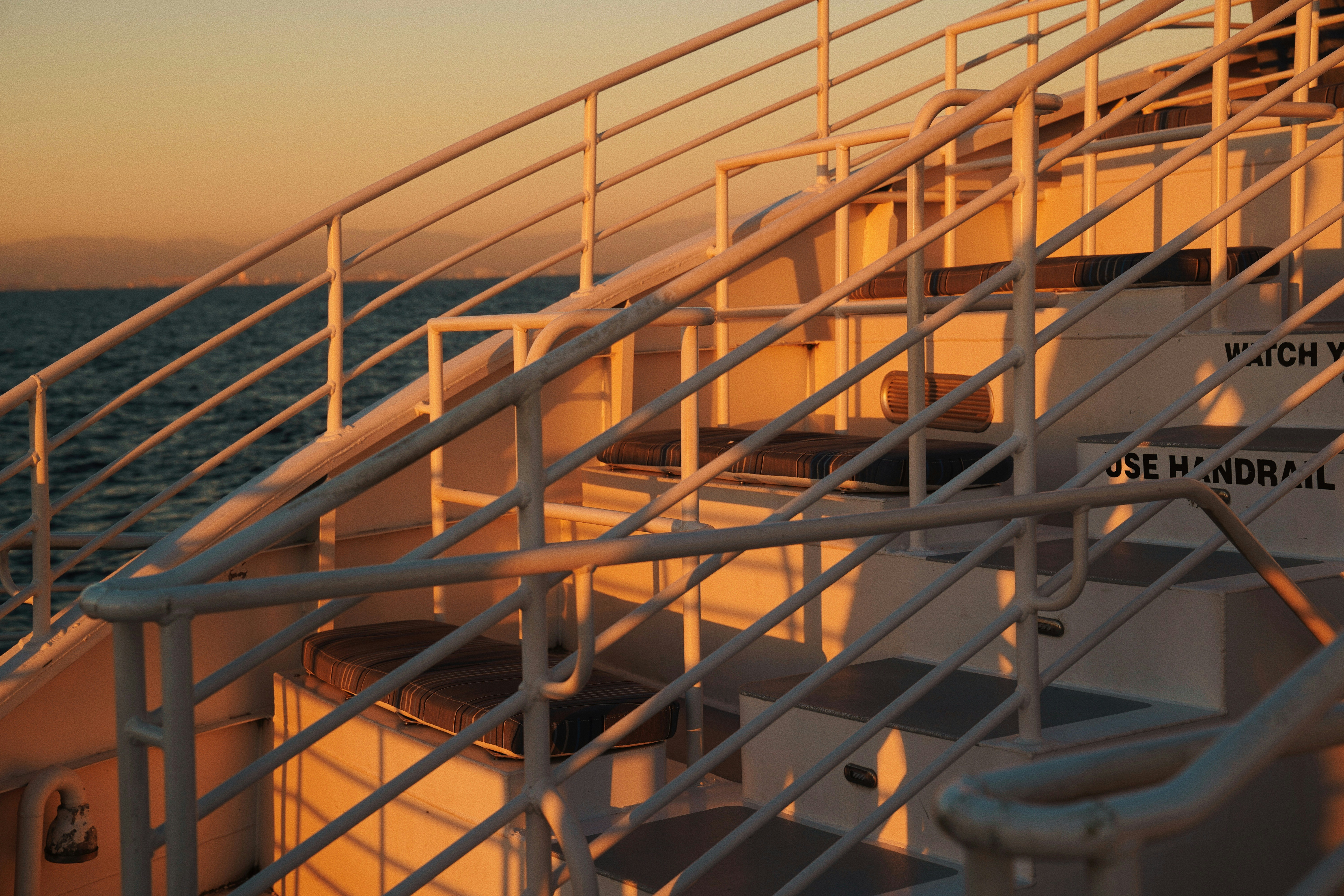 Golden Deck | White staircase on a boat at sunset