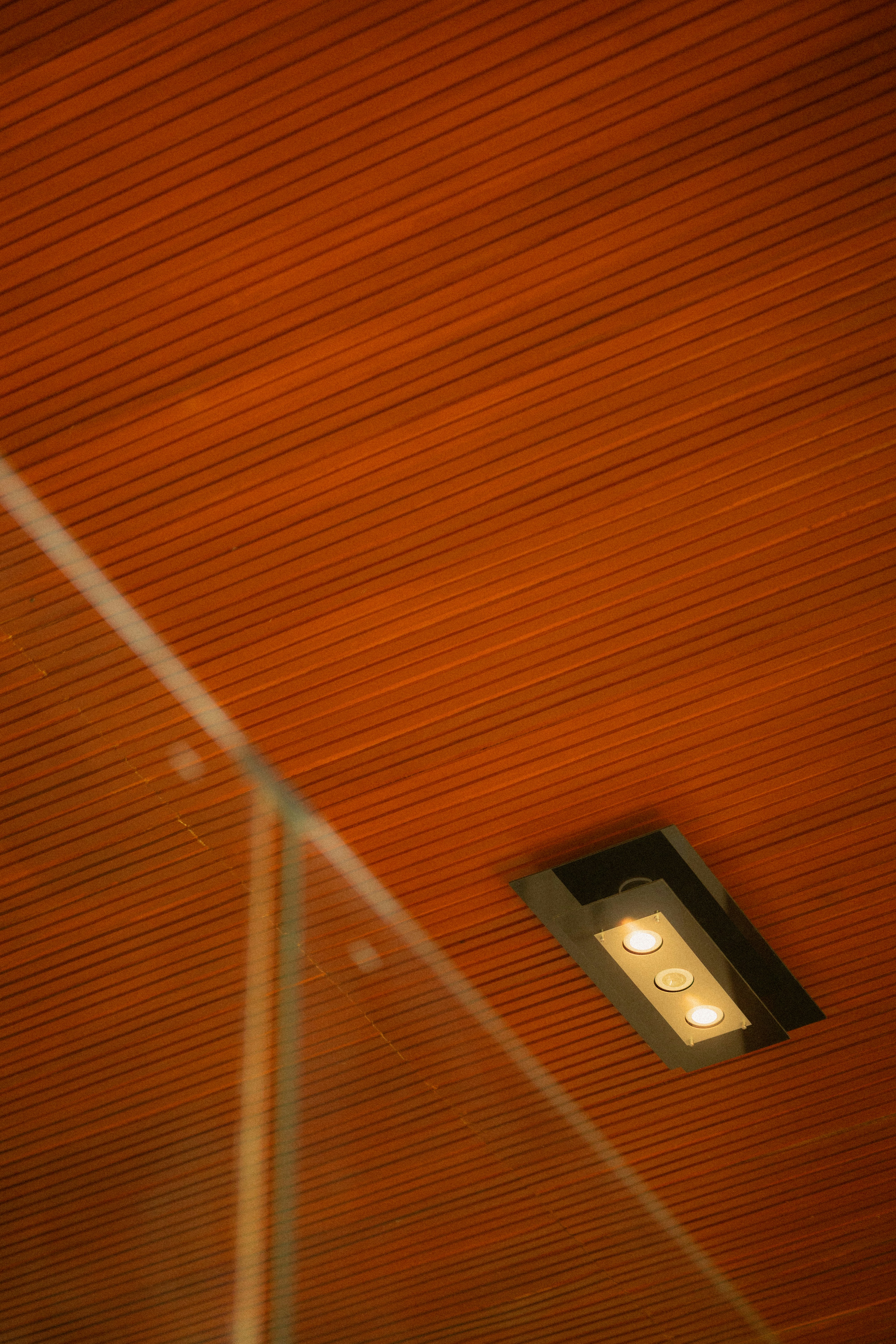 Recessed ceiling light fixture on a wood paneled ceiling. photo – Free ...