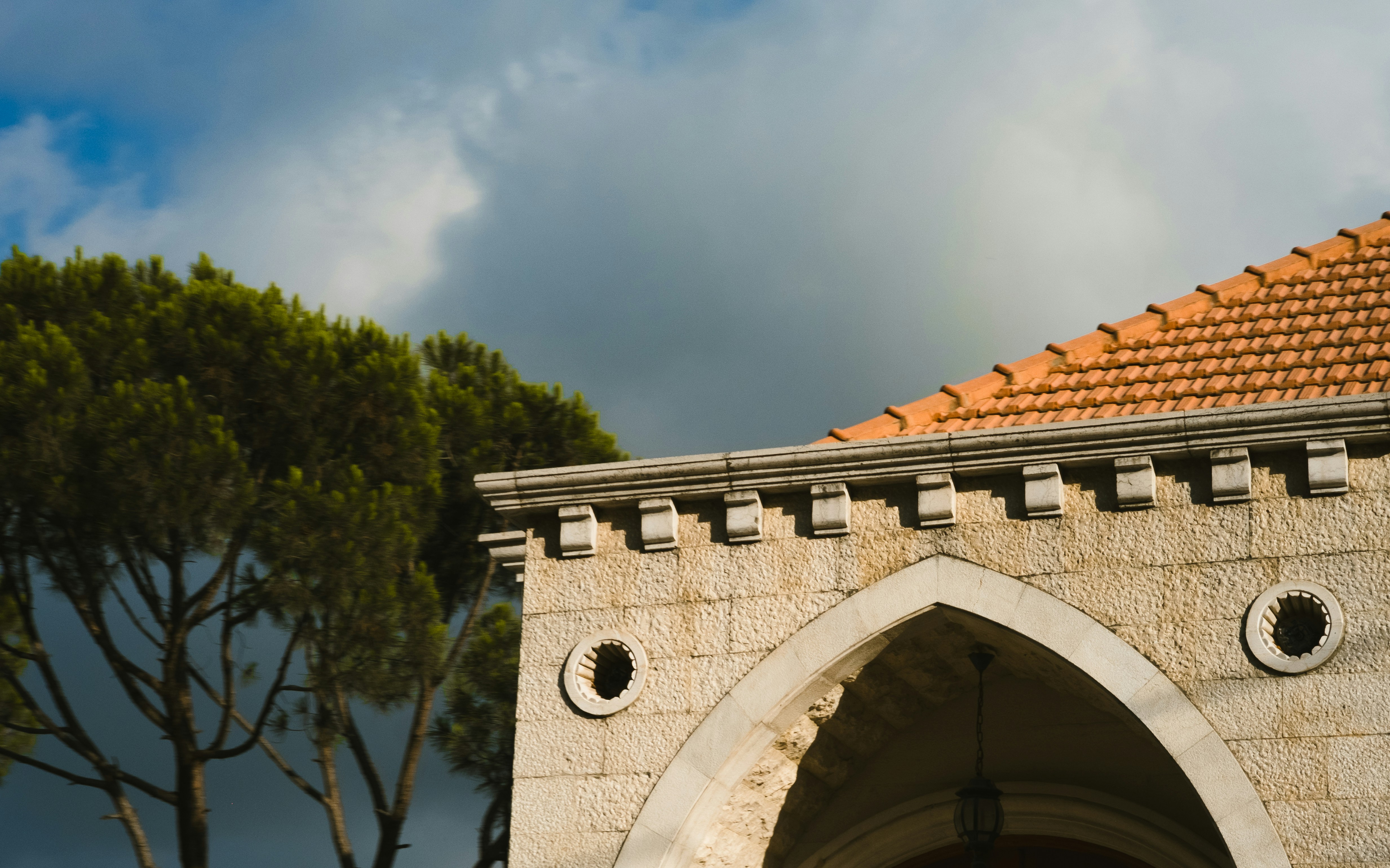 Archway of Stone and Tile: Sunlit Courtyard Portrait