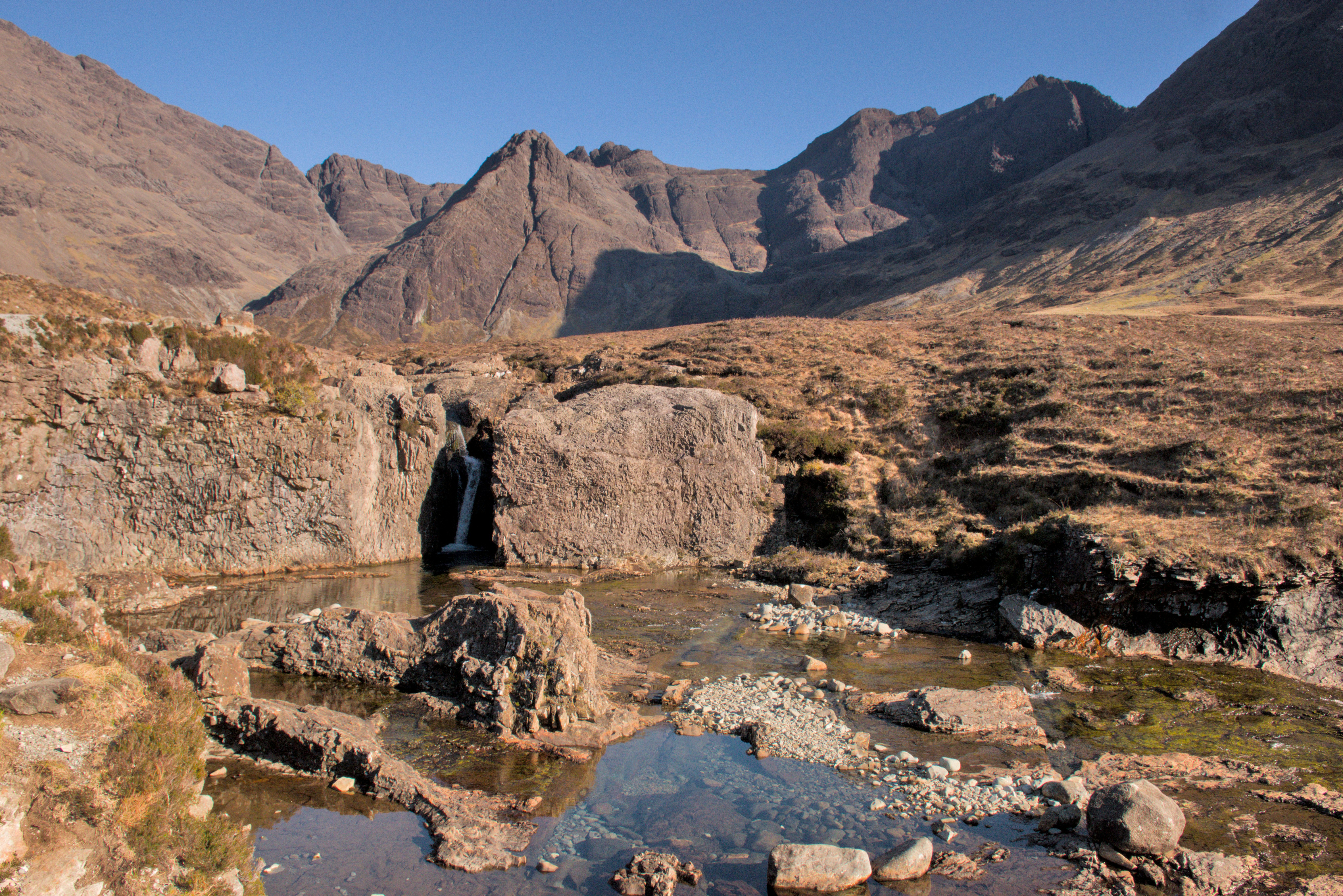 Stone Cascade and Silent Peaks: A Lone Hiker in the Desert Basin