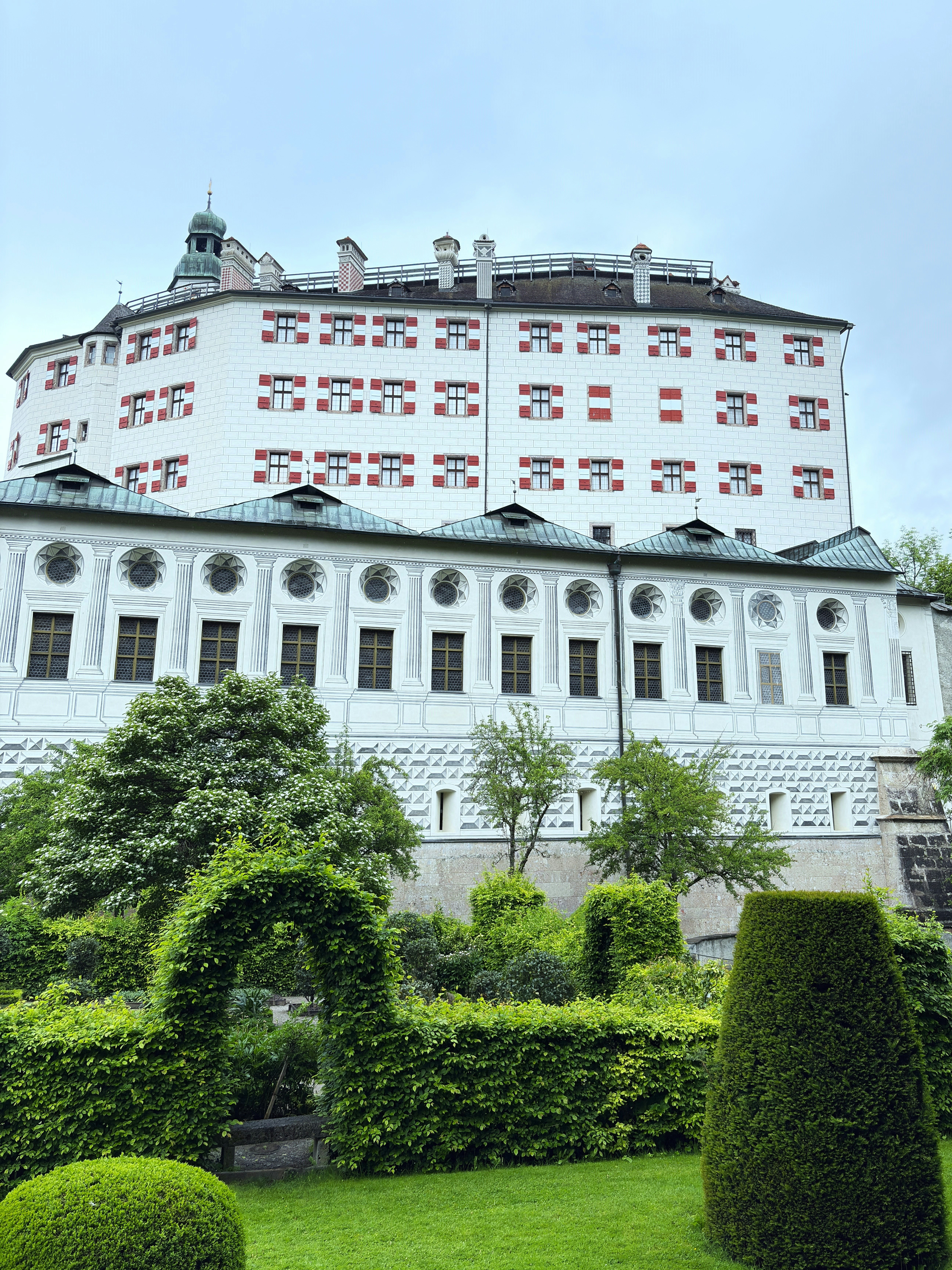 Ambras Castle, Innsbruck, Austria | Ambras castle with manicured gardens in foreground