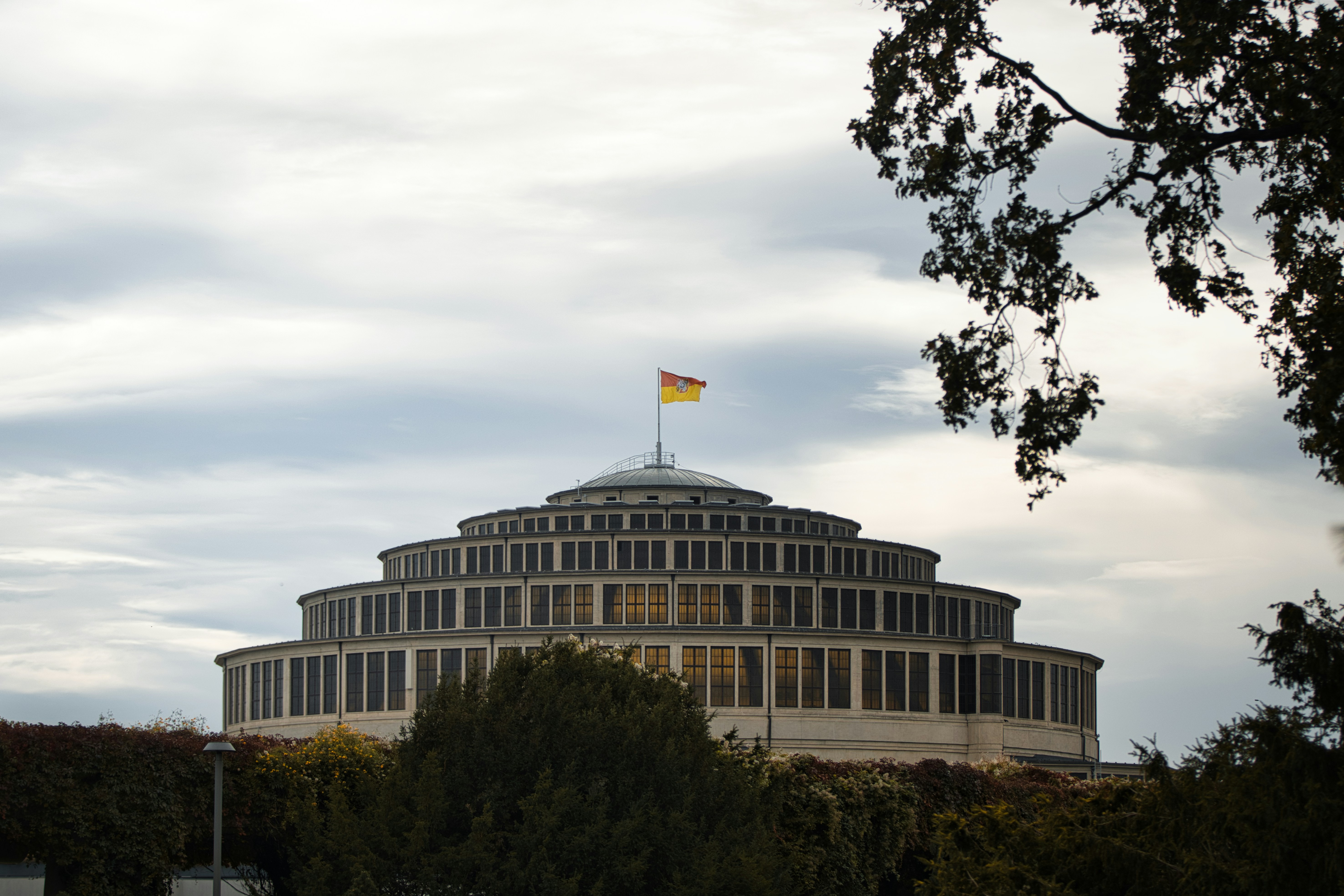 Flag at the Tiered Dome: Circular Civic Monument Reaching Toward the Sky