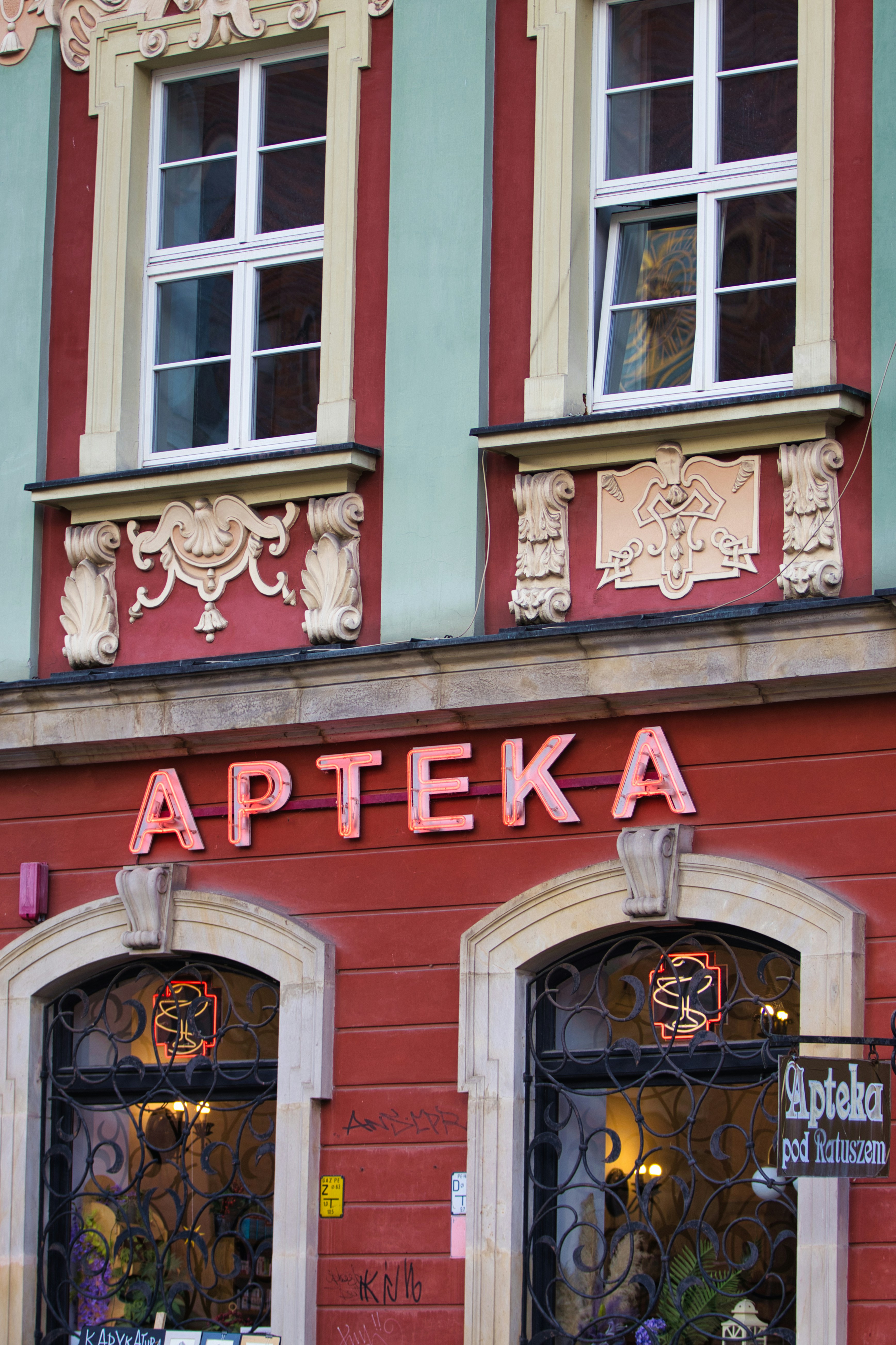 Neon APTEKA on a Multicolored Baroque Facade