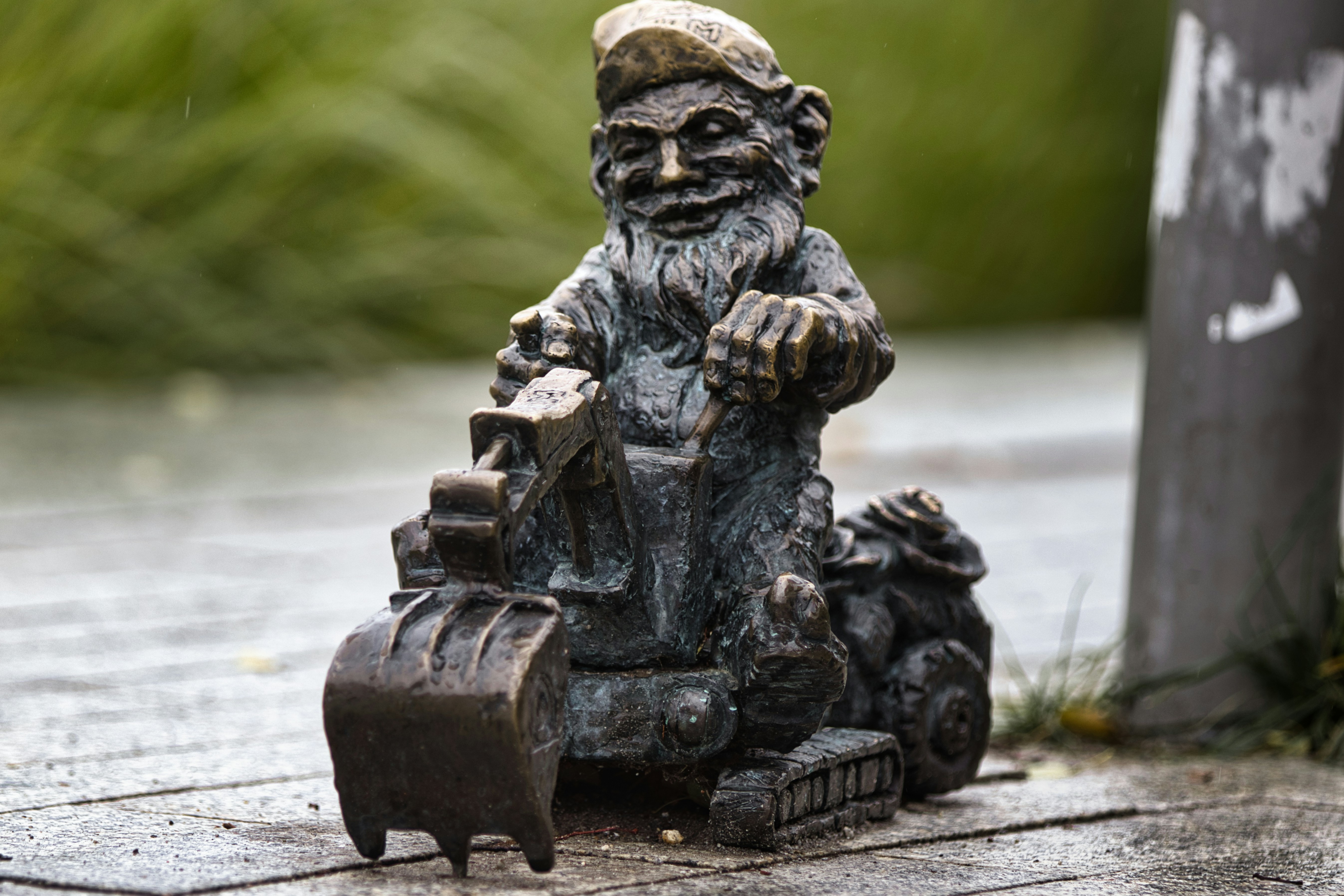 Whimsical Garden Guardian on a Mini Excavator