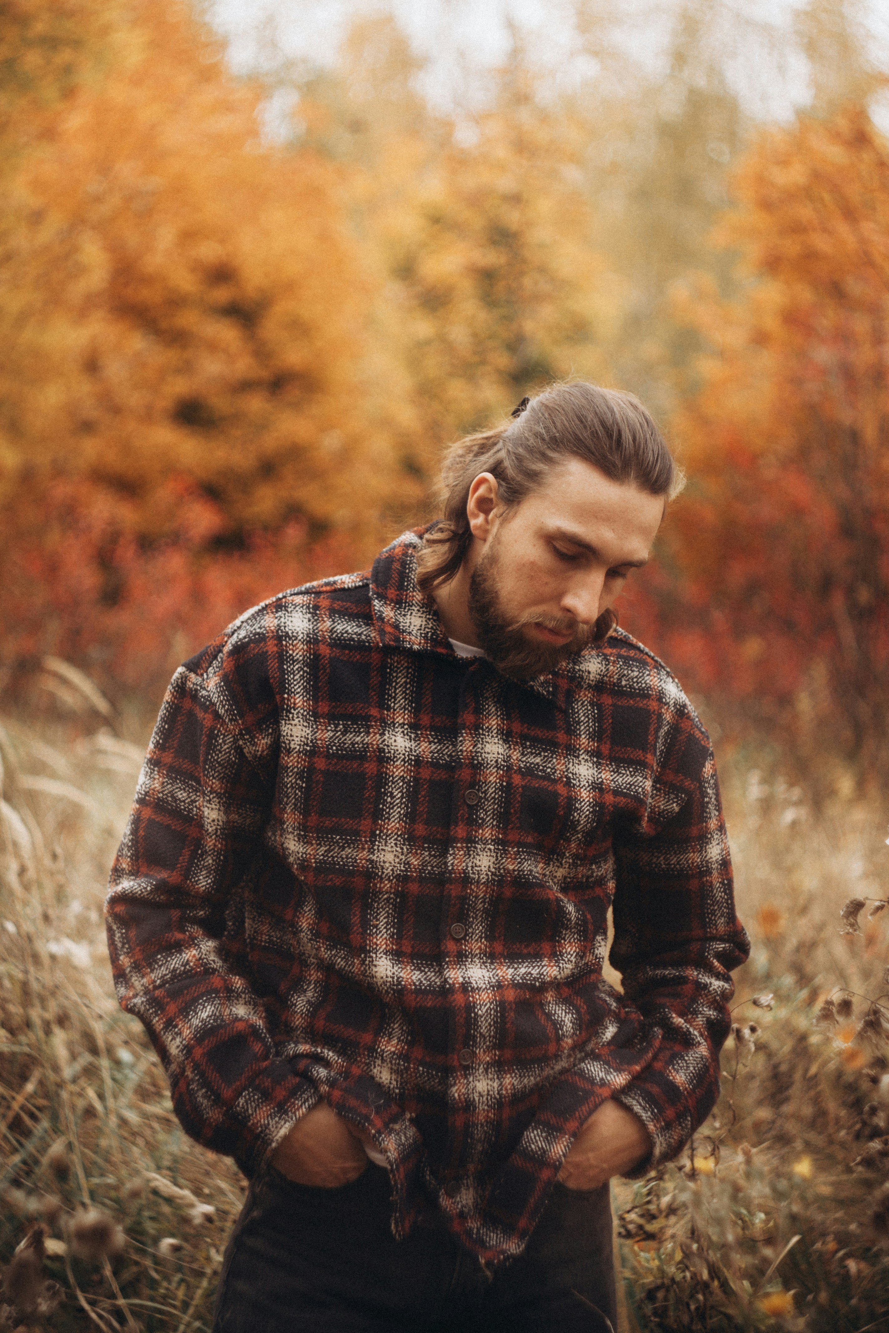 Man in plaid shirt in autumn forest