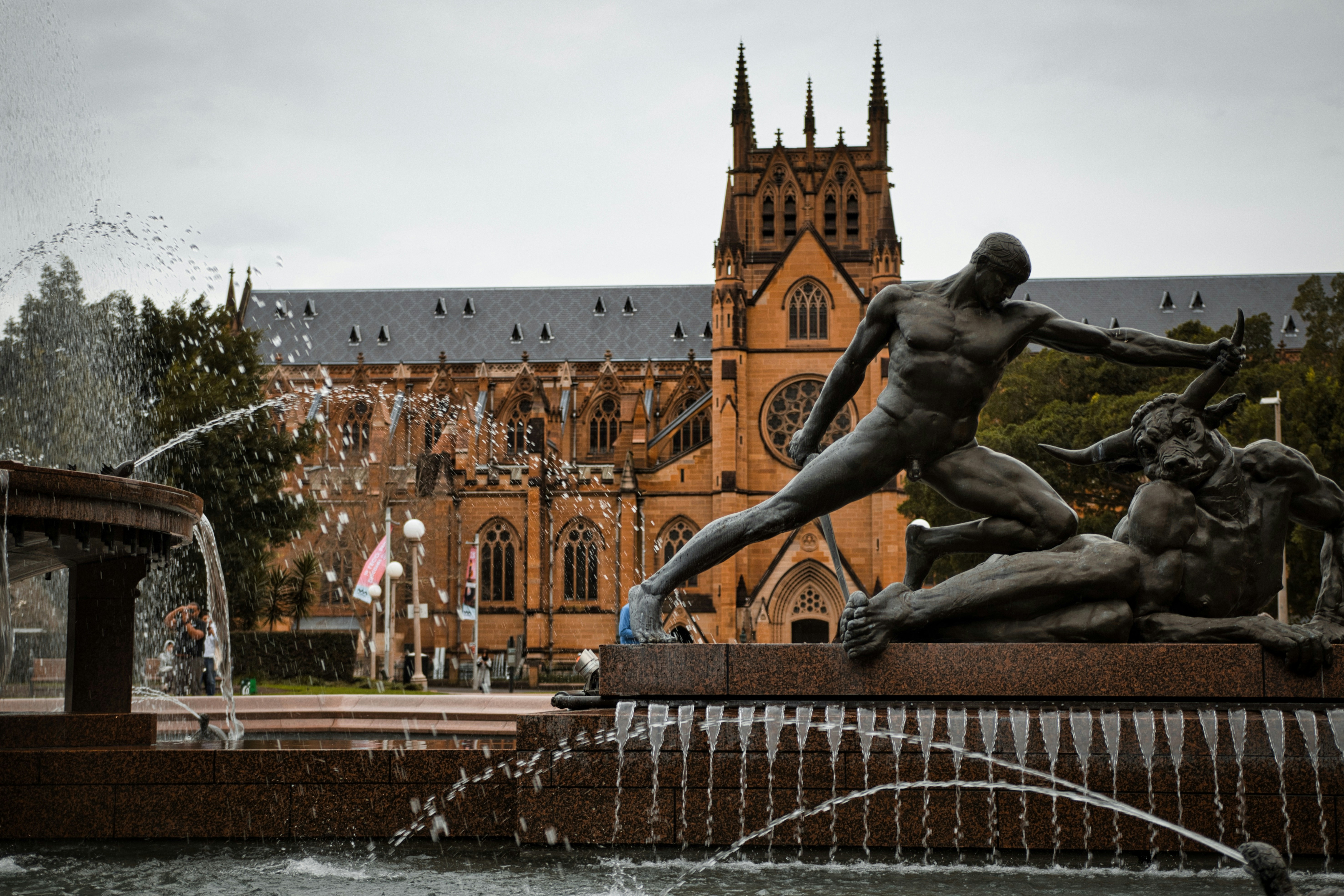 Bronze Wrestler in the Fountain: A Dynamic Moment Before a Gothic Cathedral