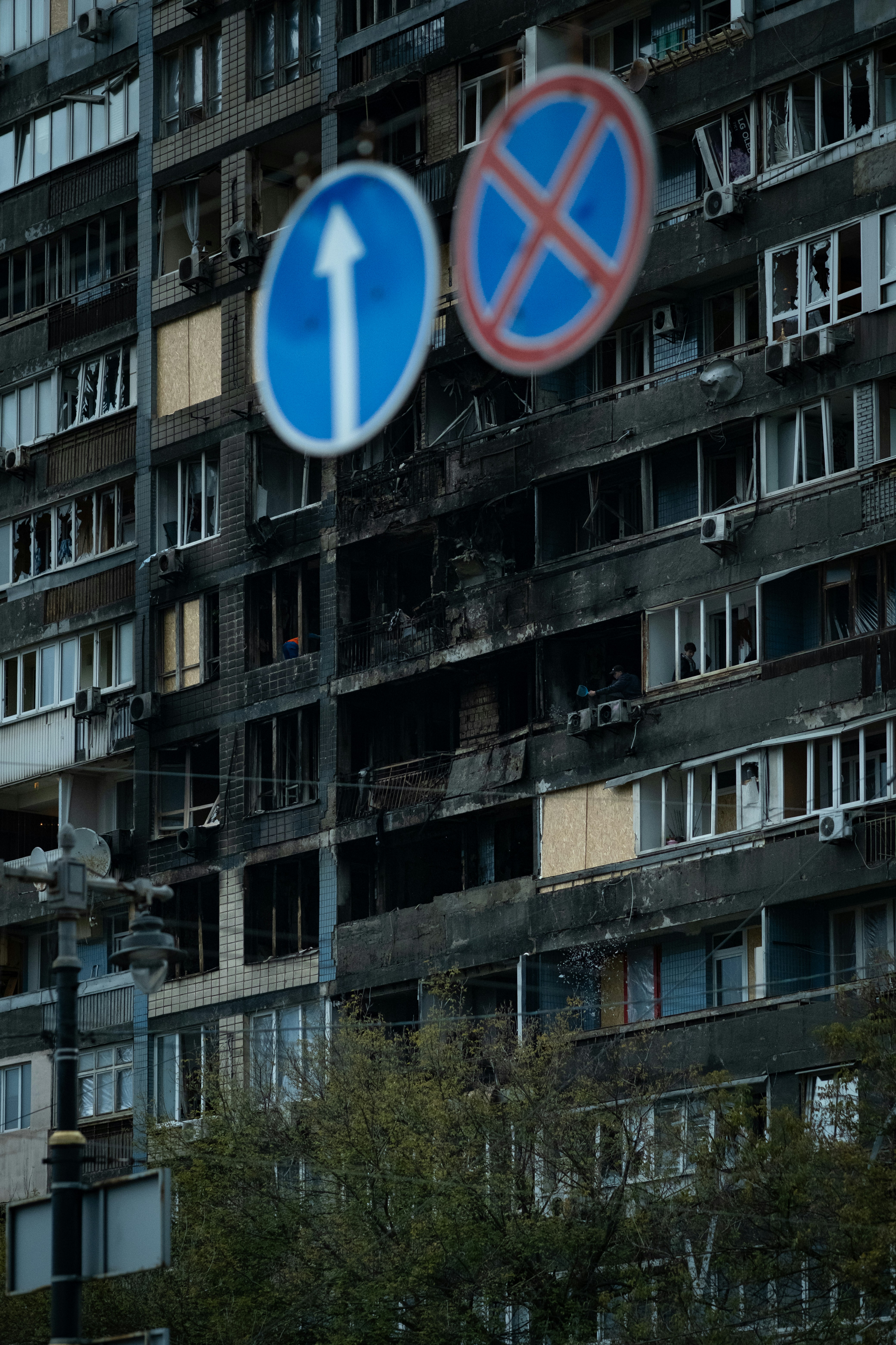 Damaged apartment building with traffic signs