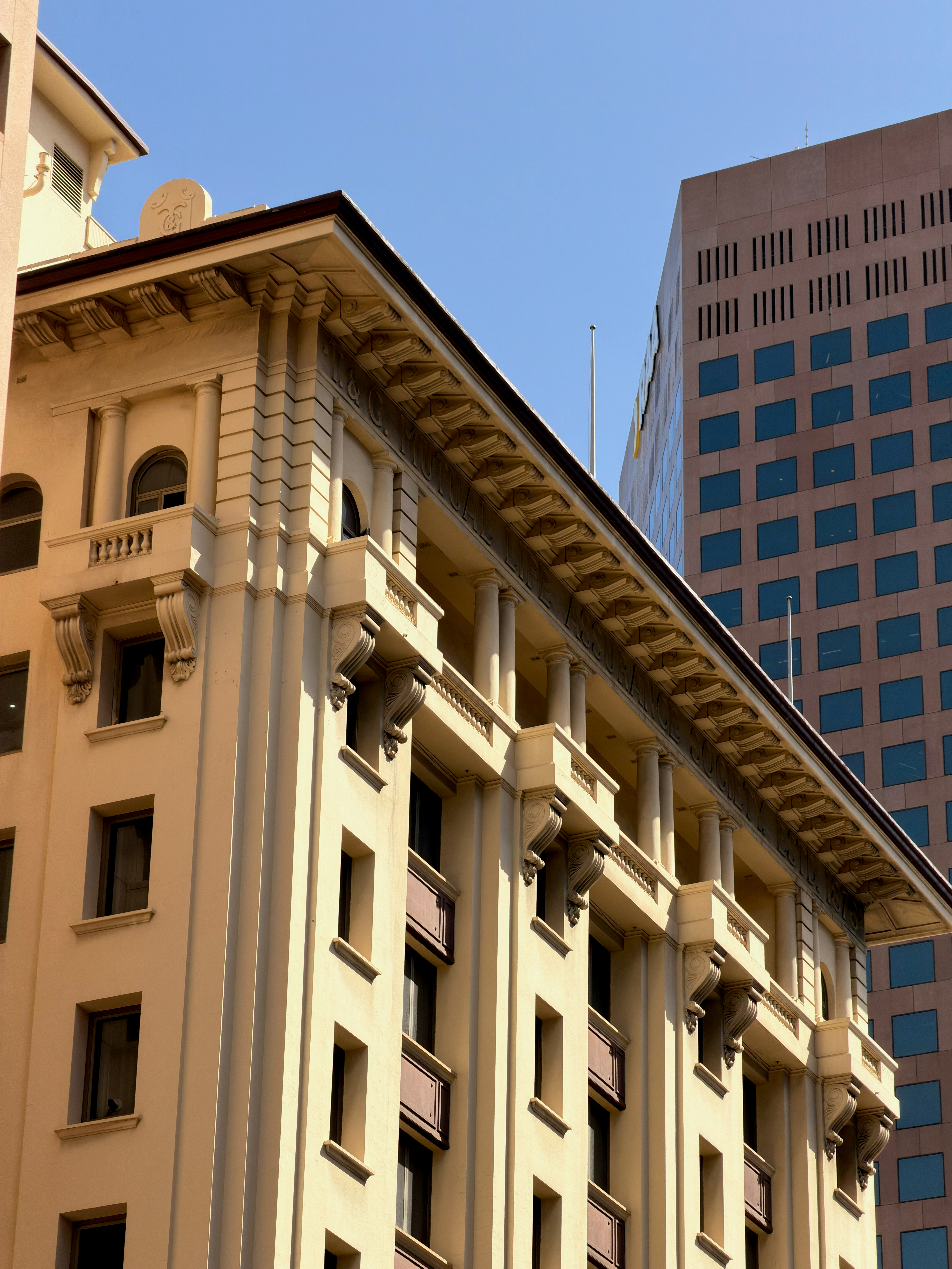 Sunlit Neoclassical Facade Stearing Toward a Modern Sky