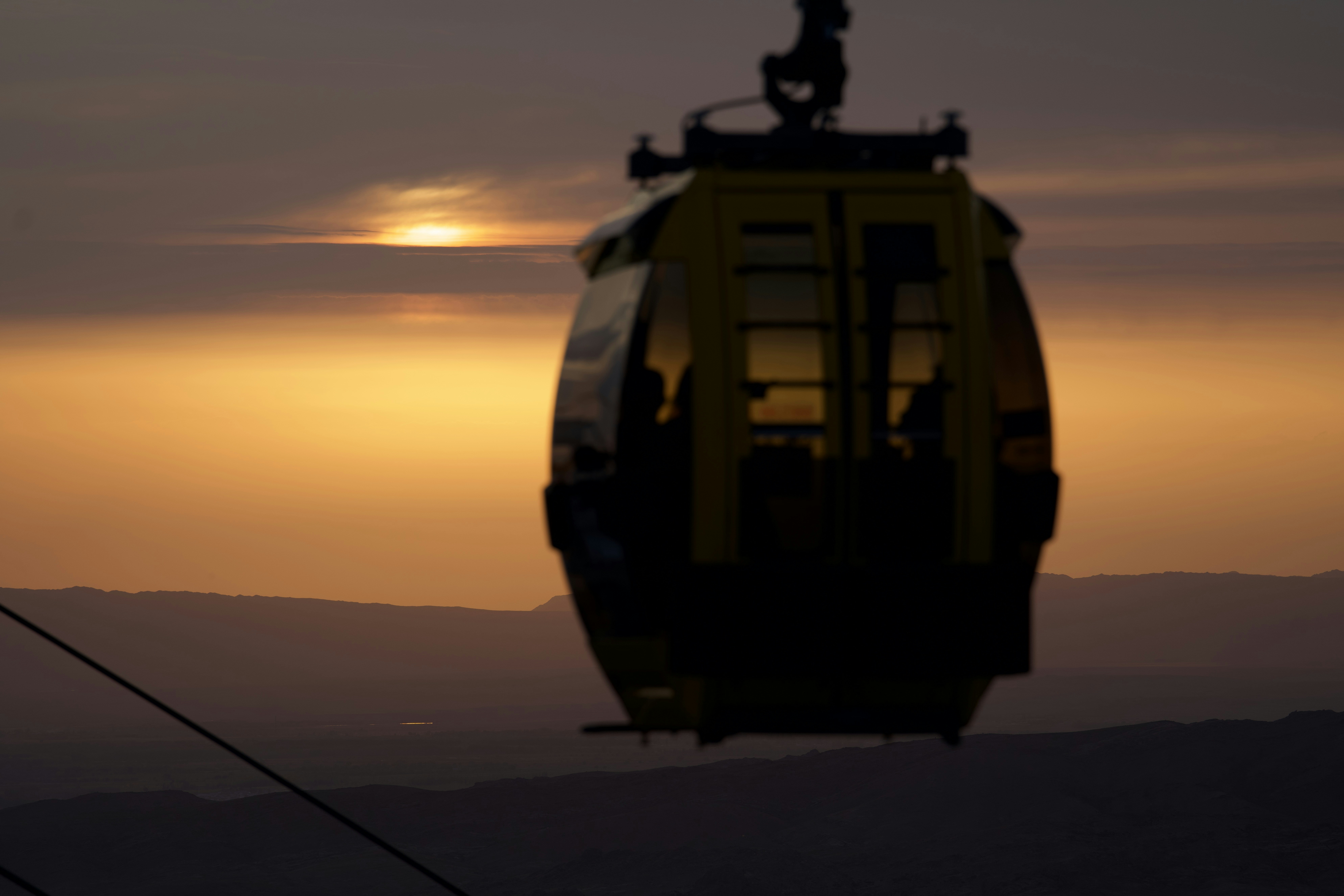 Ascending Through Dusk: A Gondola's Journey