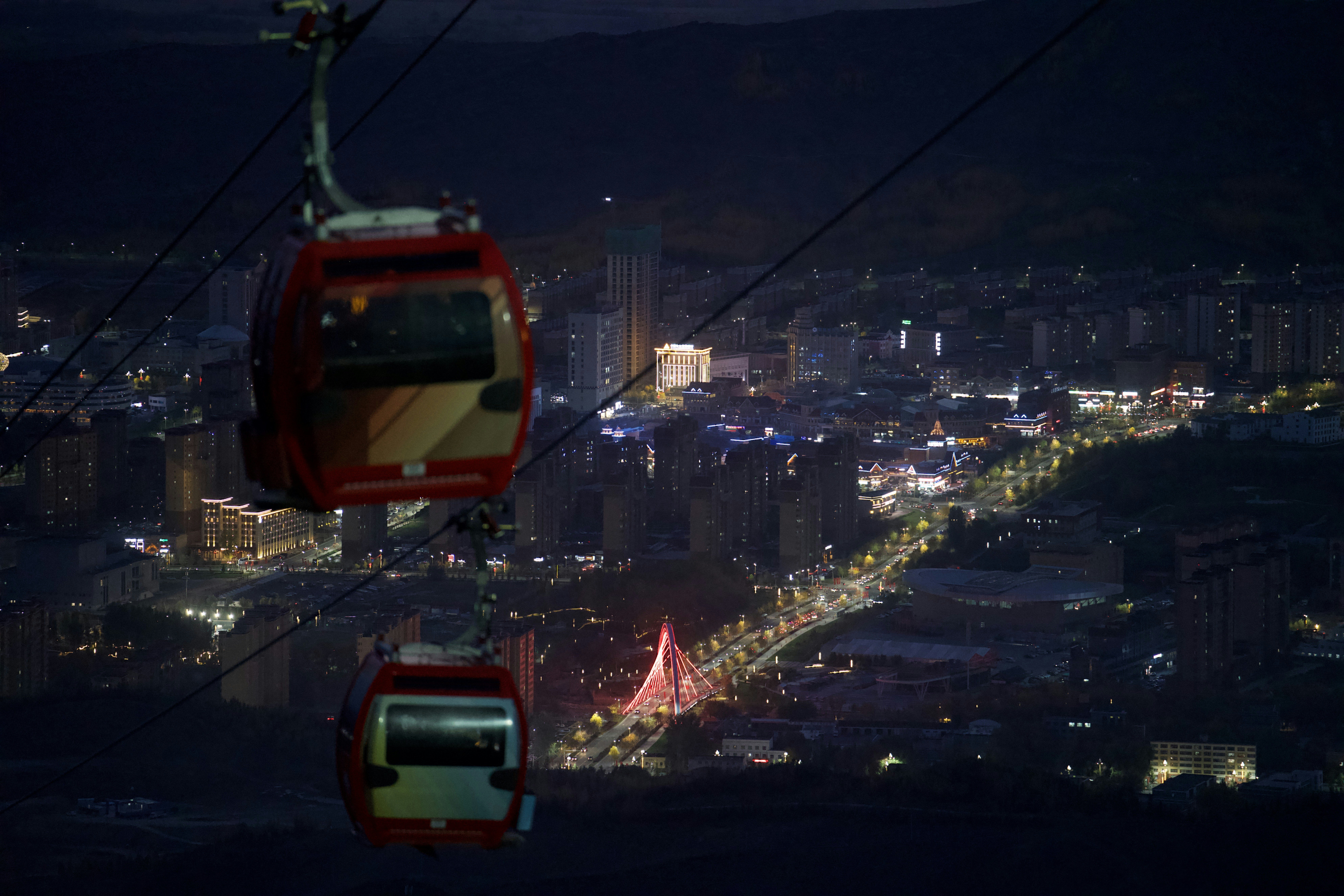 Crimson Cable Cars Drift Over a Neon Night Cityscape