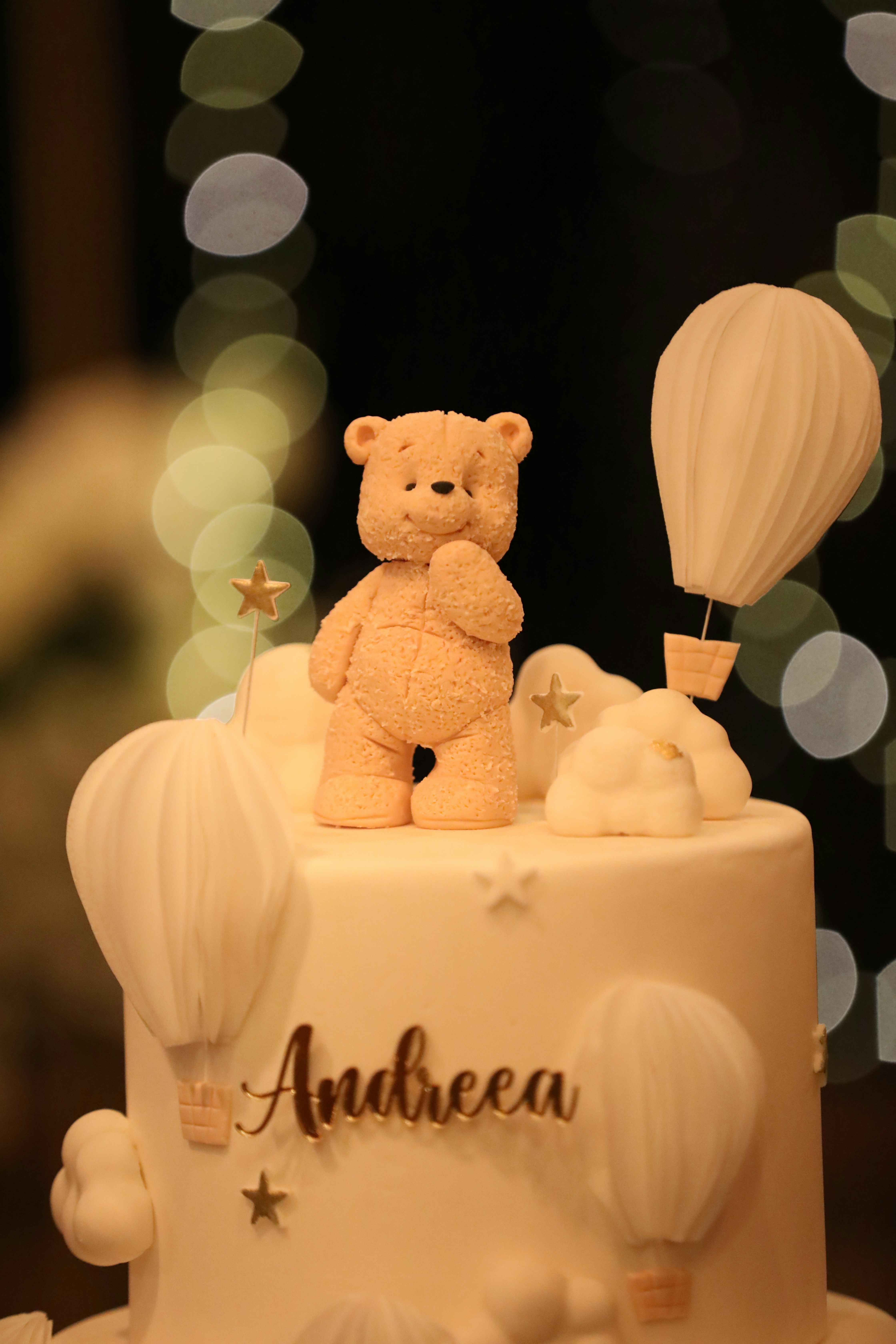 Teddy bear cake with hot air balloons and stars.