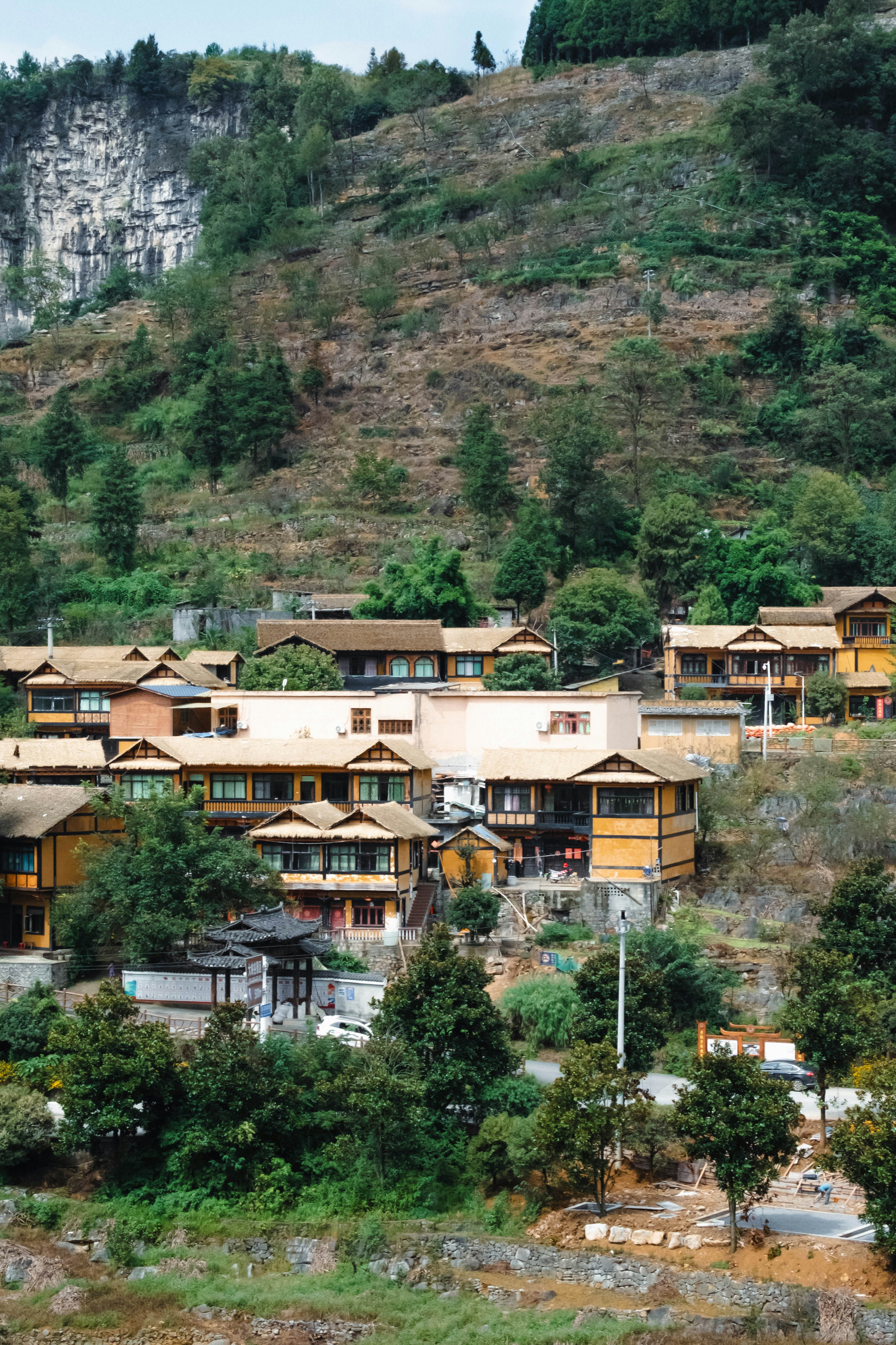 Village nestled on a green, rocky mountainside.