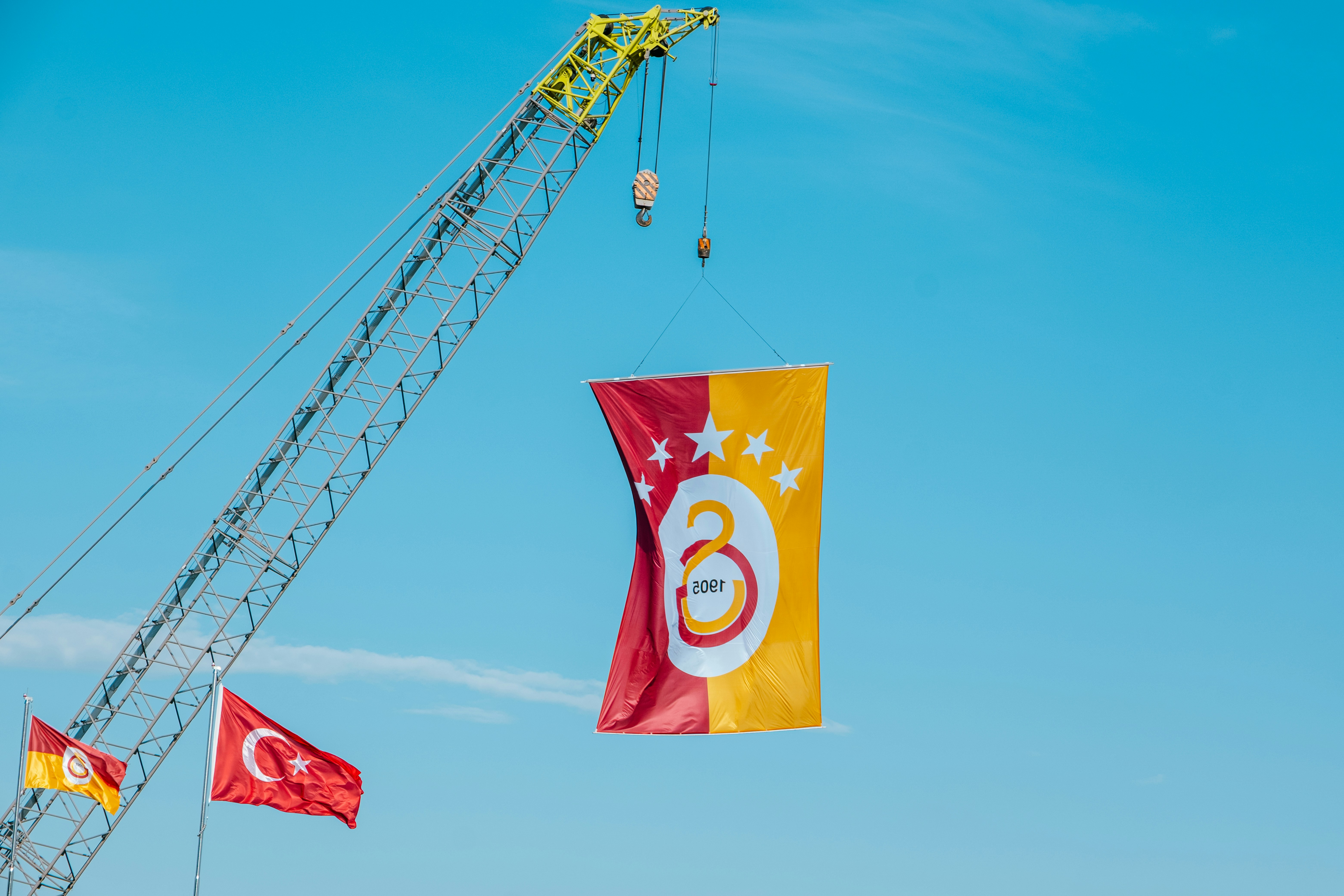 Crane lifting galatasaray and turkish flags photo – Free Flag Image on ...