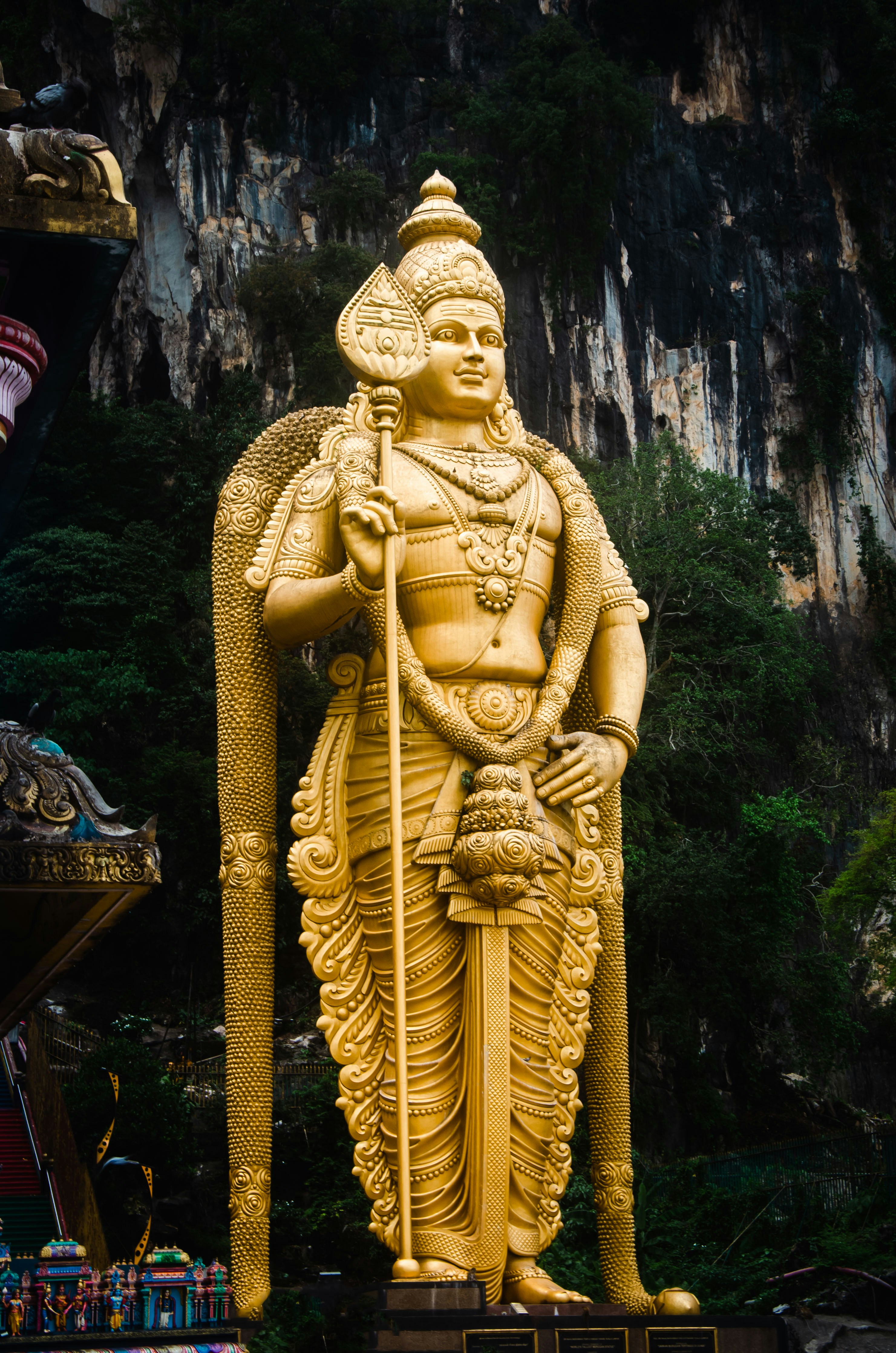 A large golden statue of a hindu deity photo – Free Worship Image on ...