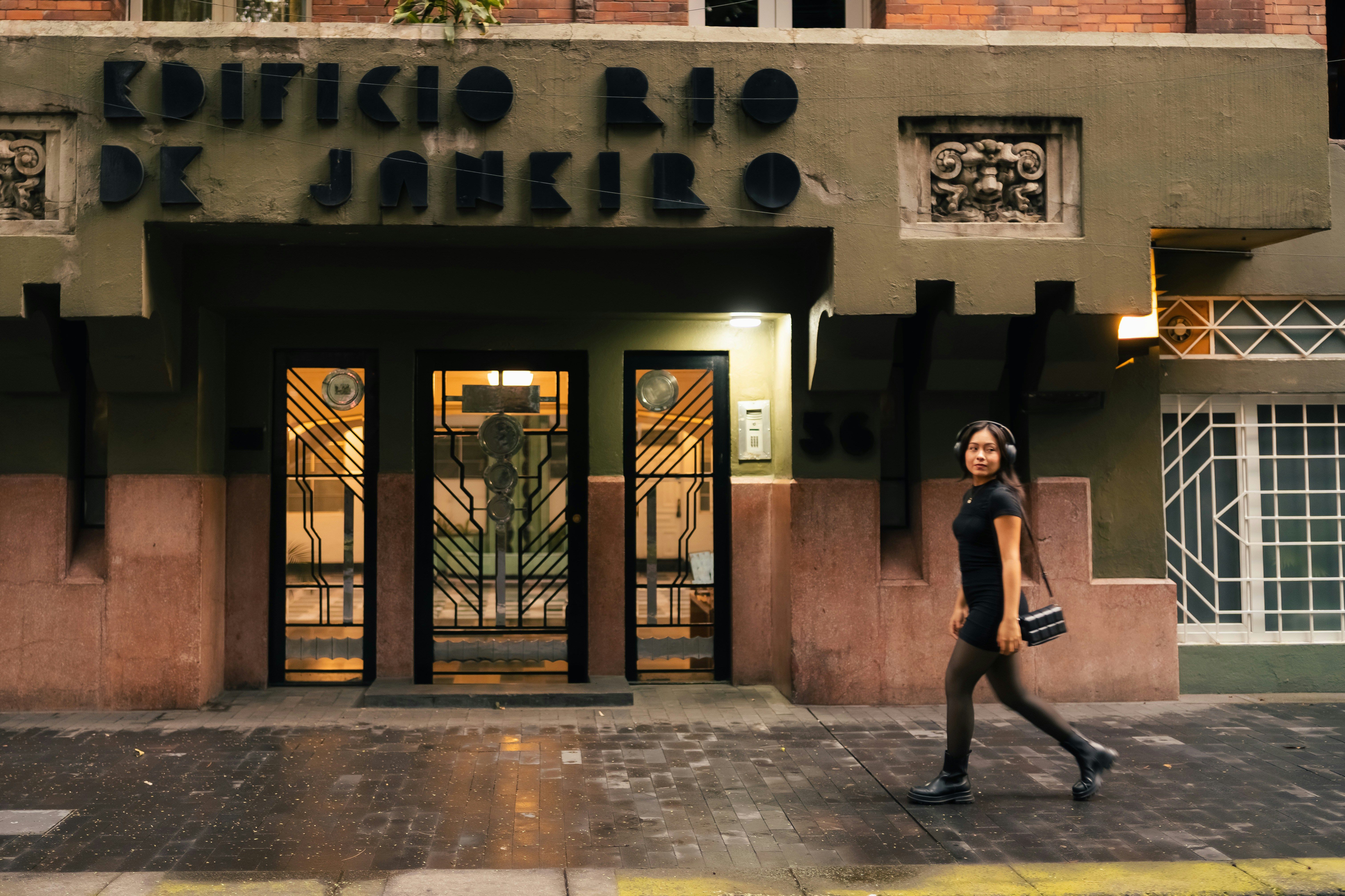 Woman walks past the edificio rio de janeiro building