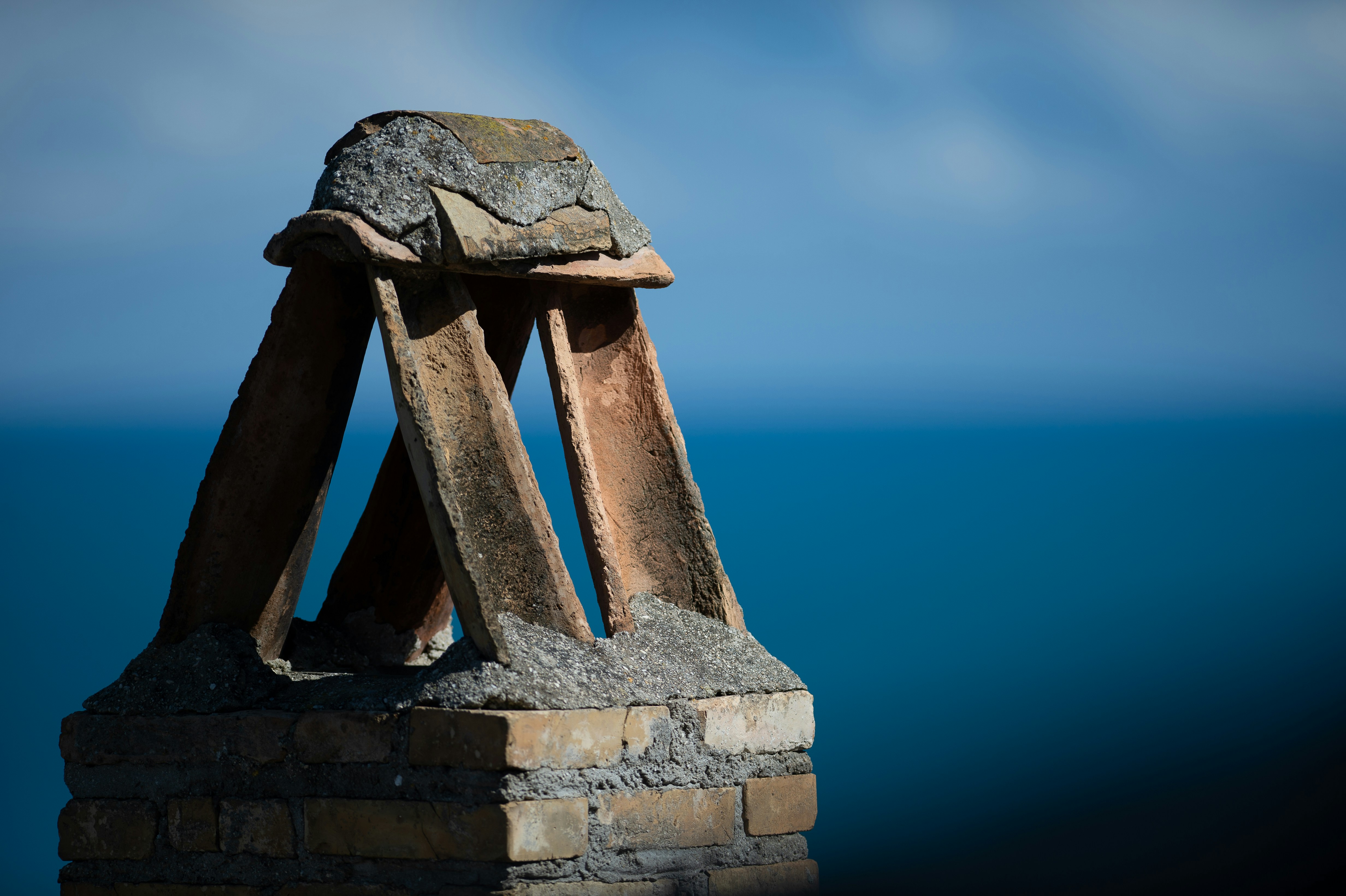 Brick Turret by the Sea: A Weathered Obelisk Against a Distant Horizon