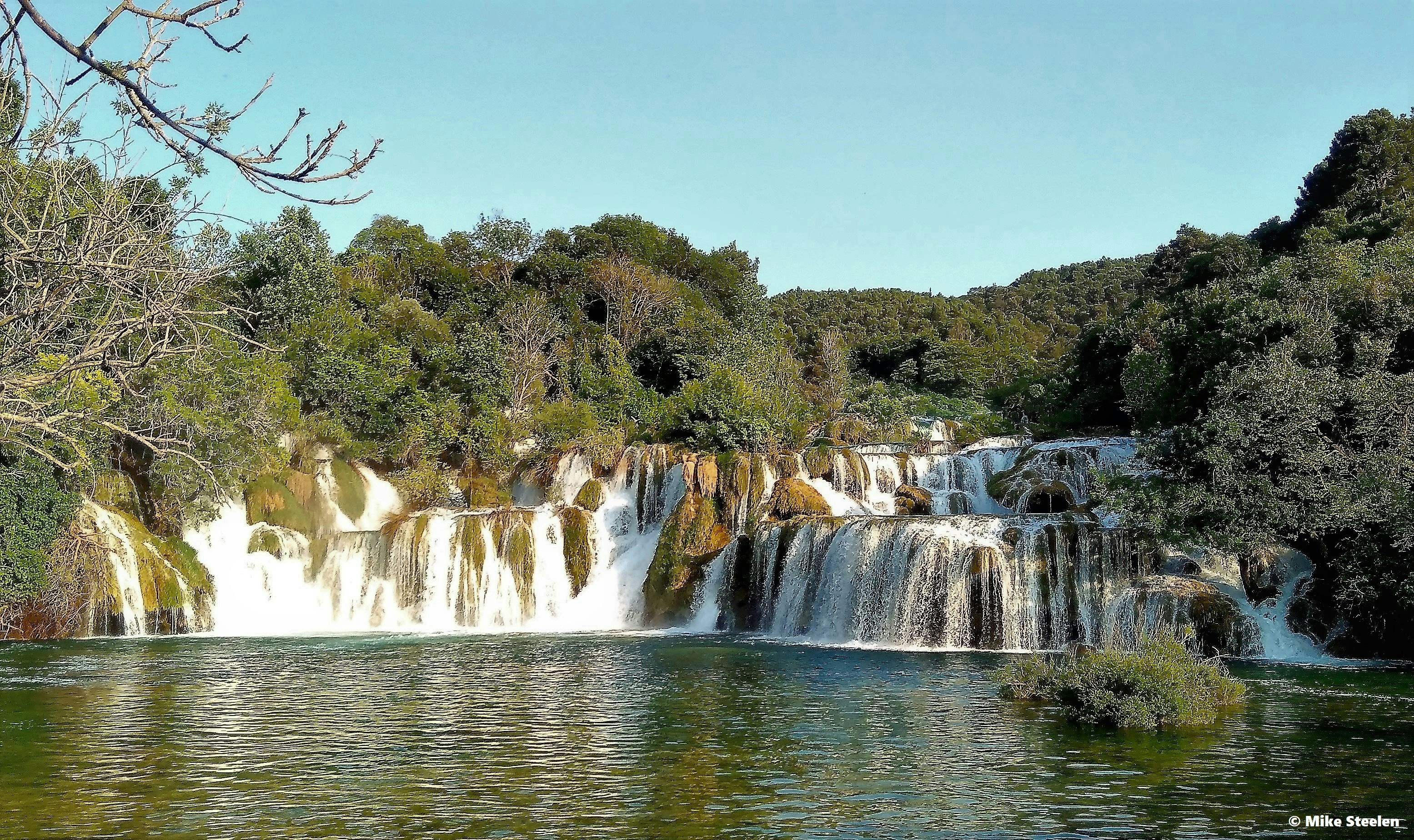 A beautiful waterfall cascading into a serene pool.