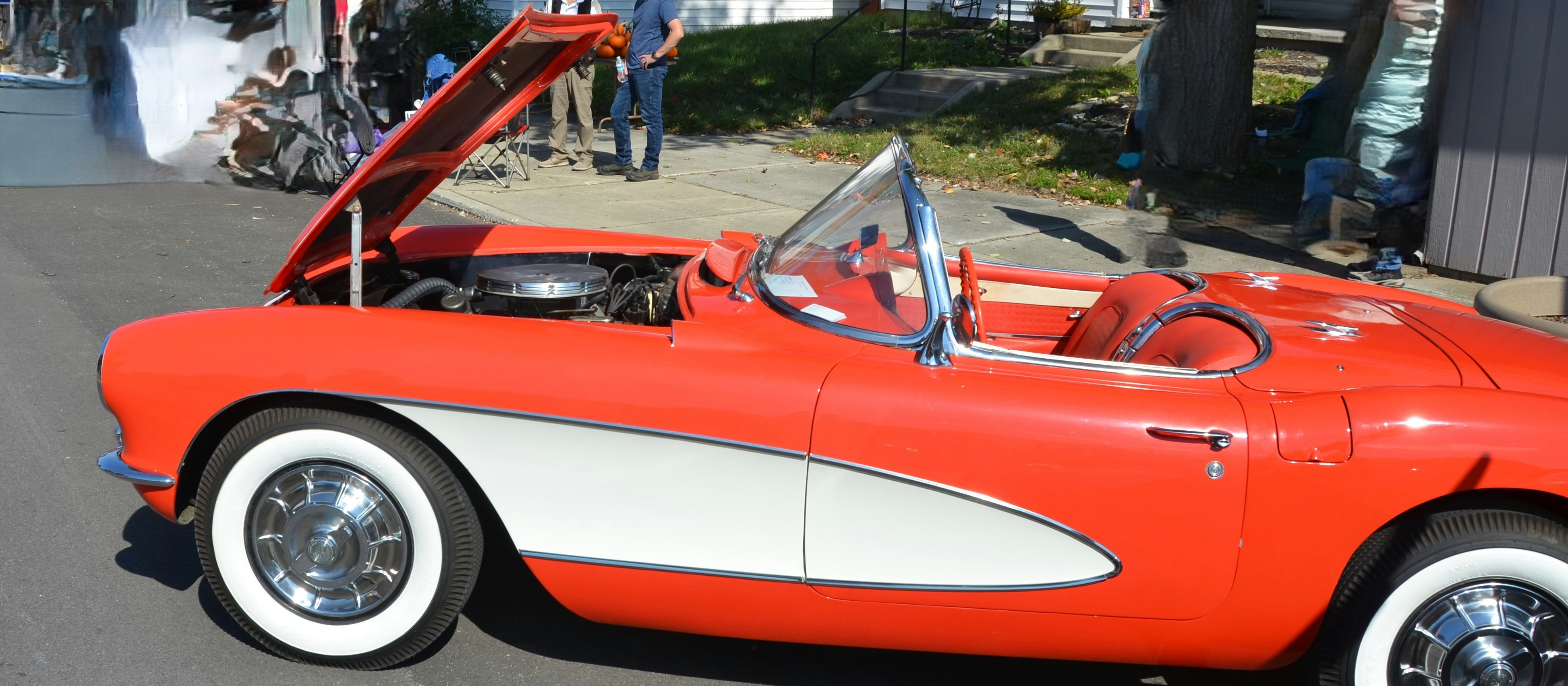 Crimson Roadster: A Vintage Convertible with White Swoosh on a Sunny Street