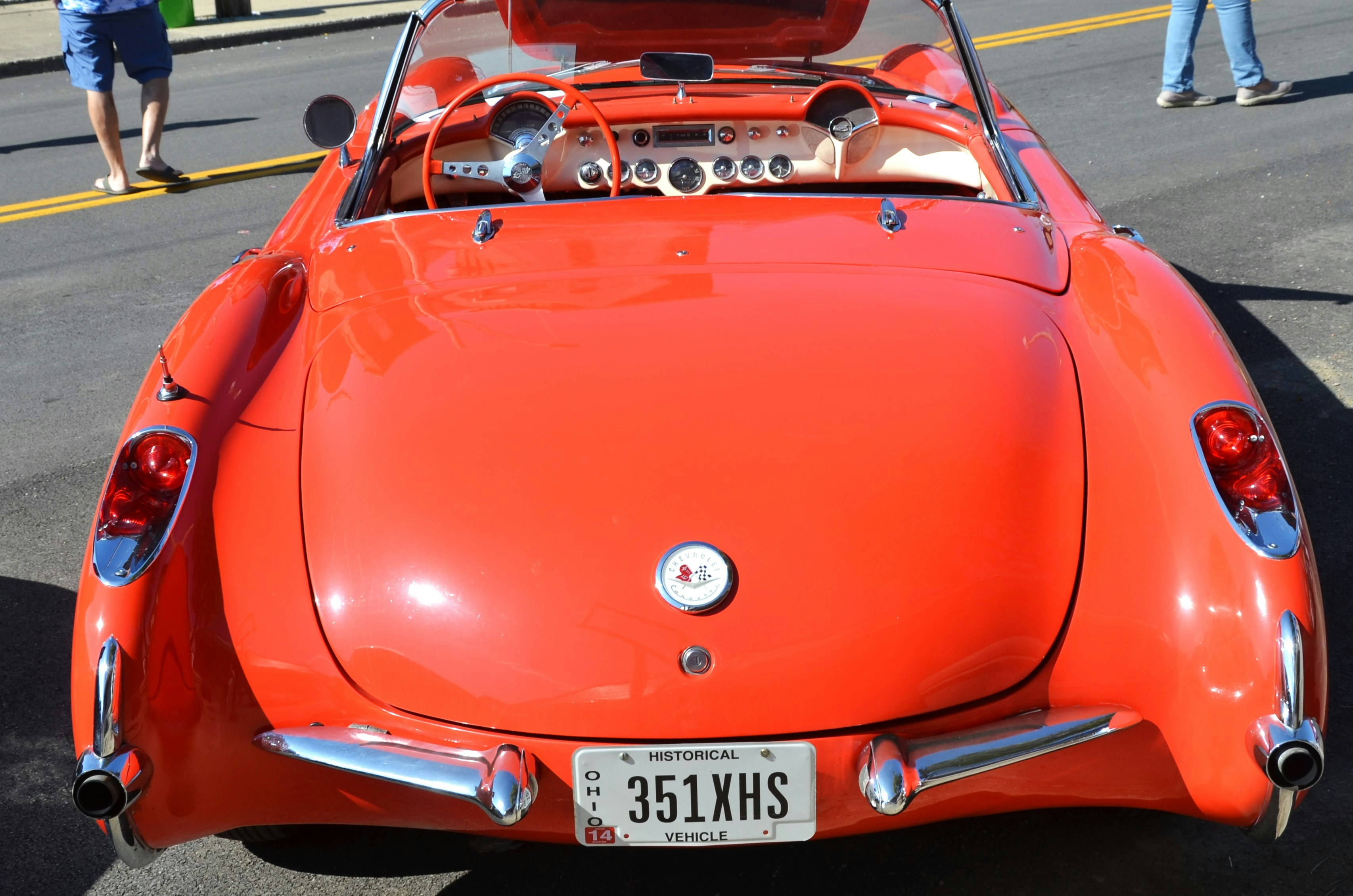 Rear View of a Bright Orange Convertible at a Car Show