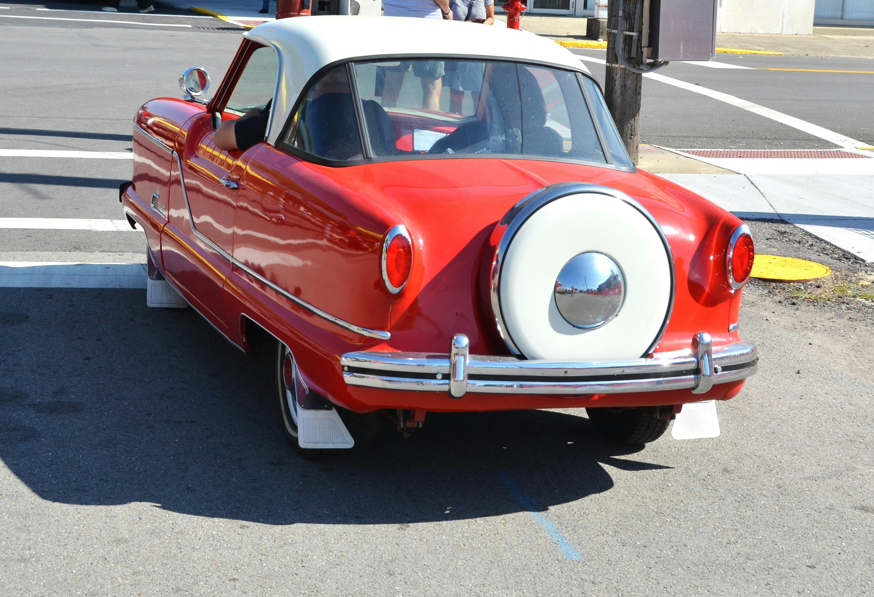 Crimson Classic: Chrome-Crowned Rear View on a Quiet Street