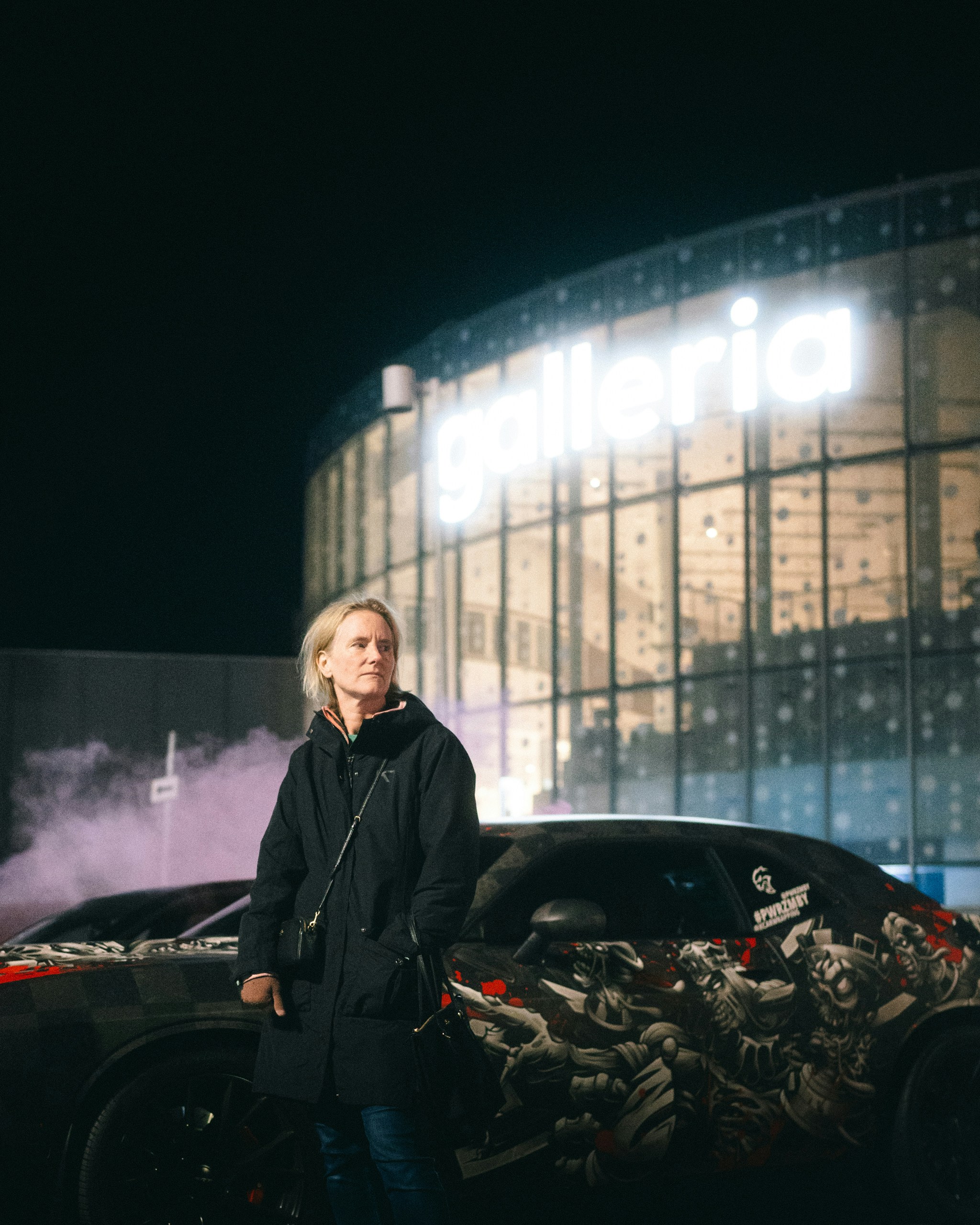 Midnight Portrait at the Galleria: A Figure by a Graffiti-Wrapped Car