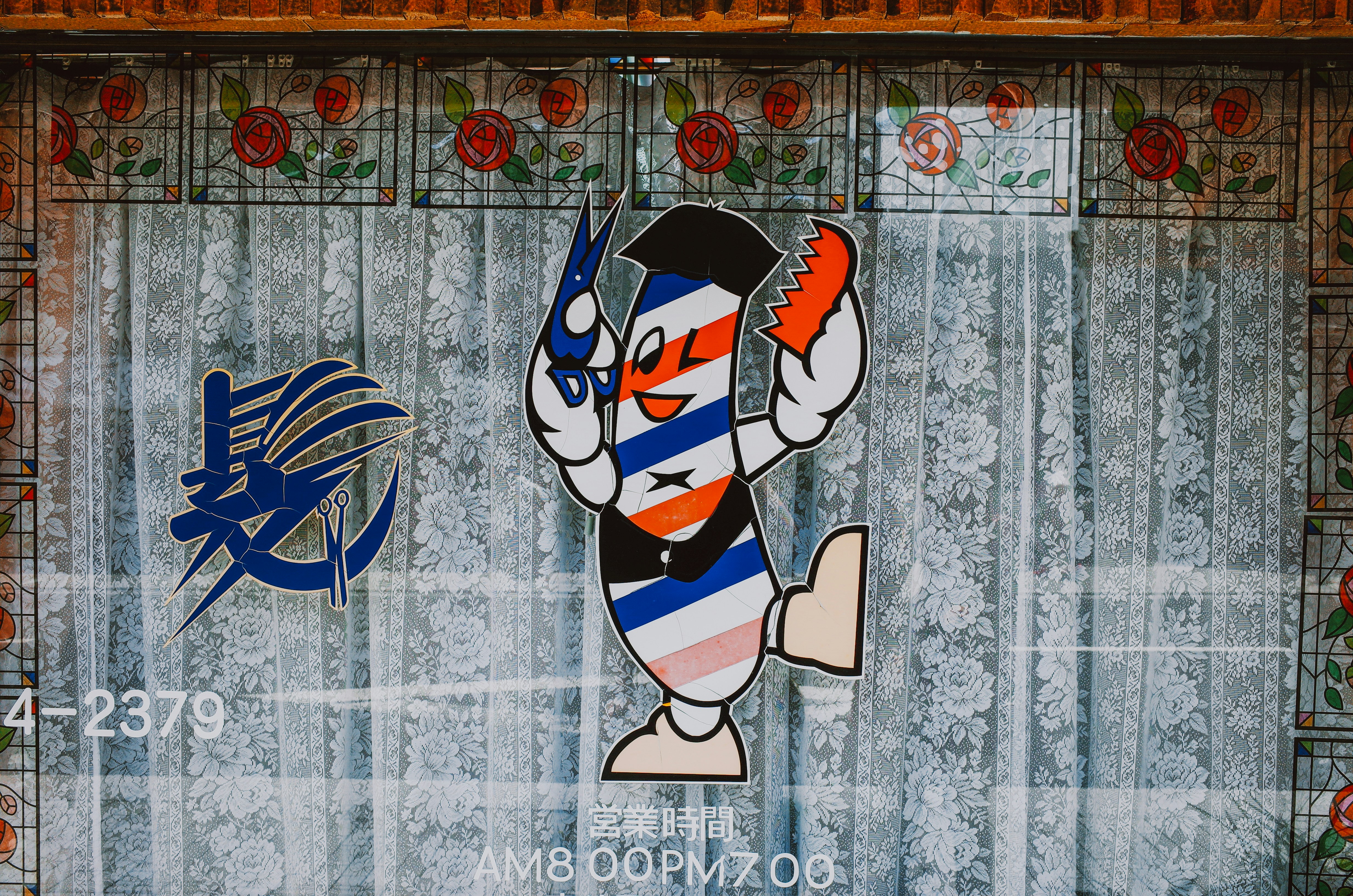 Colorful cartoon character with scissors and a comb, set against a decorative window backdrop featuring floral patterns.