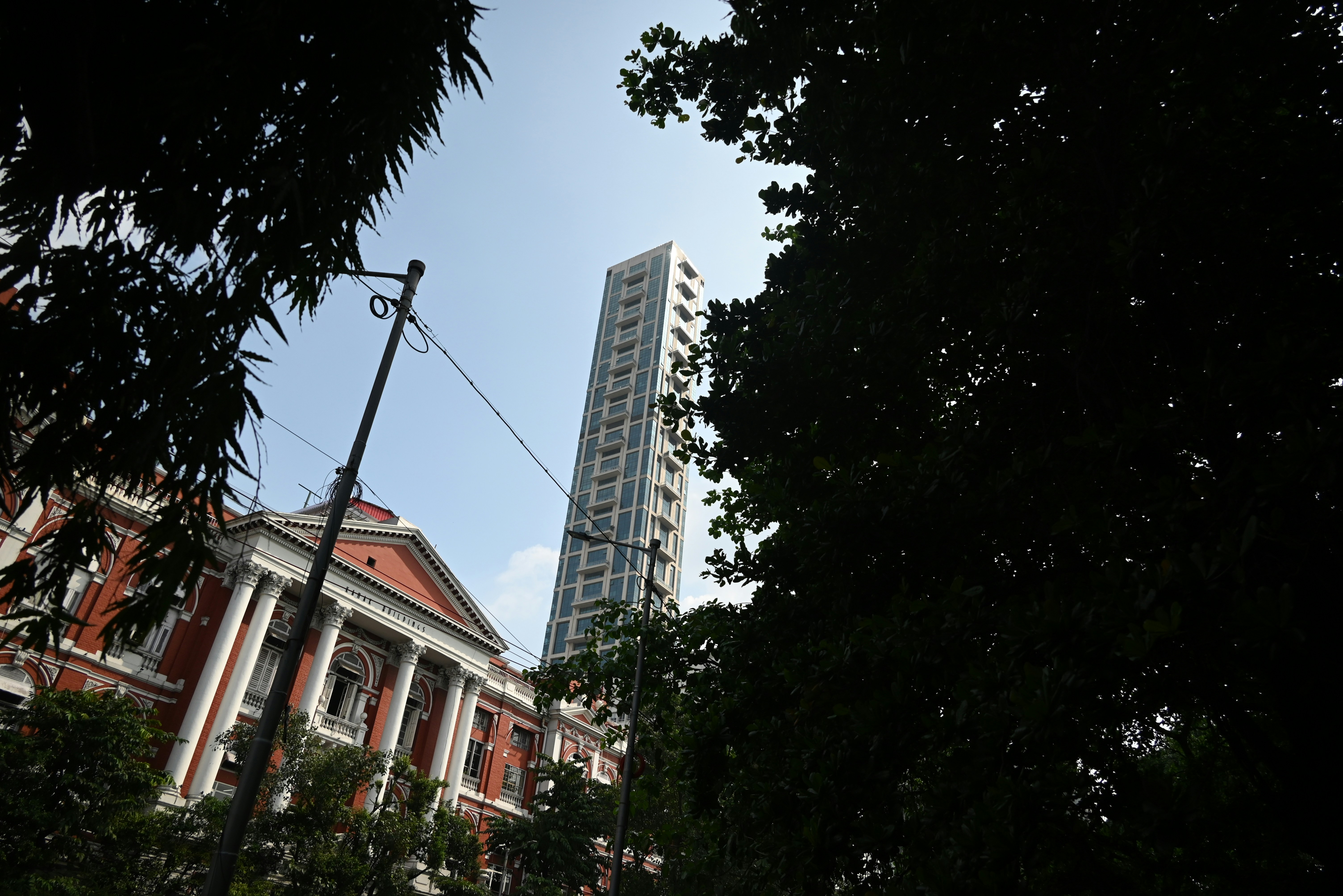 Contrasting Eras: A Modern Tower Amidst Historical Architecture