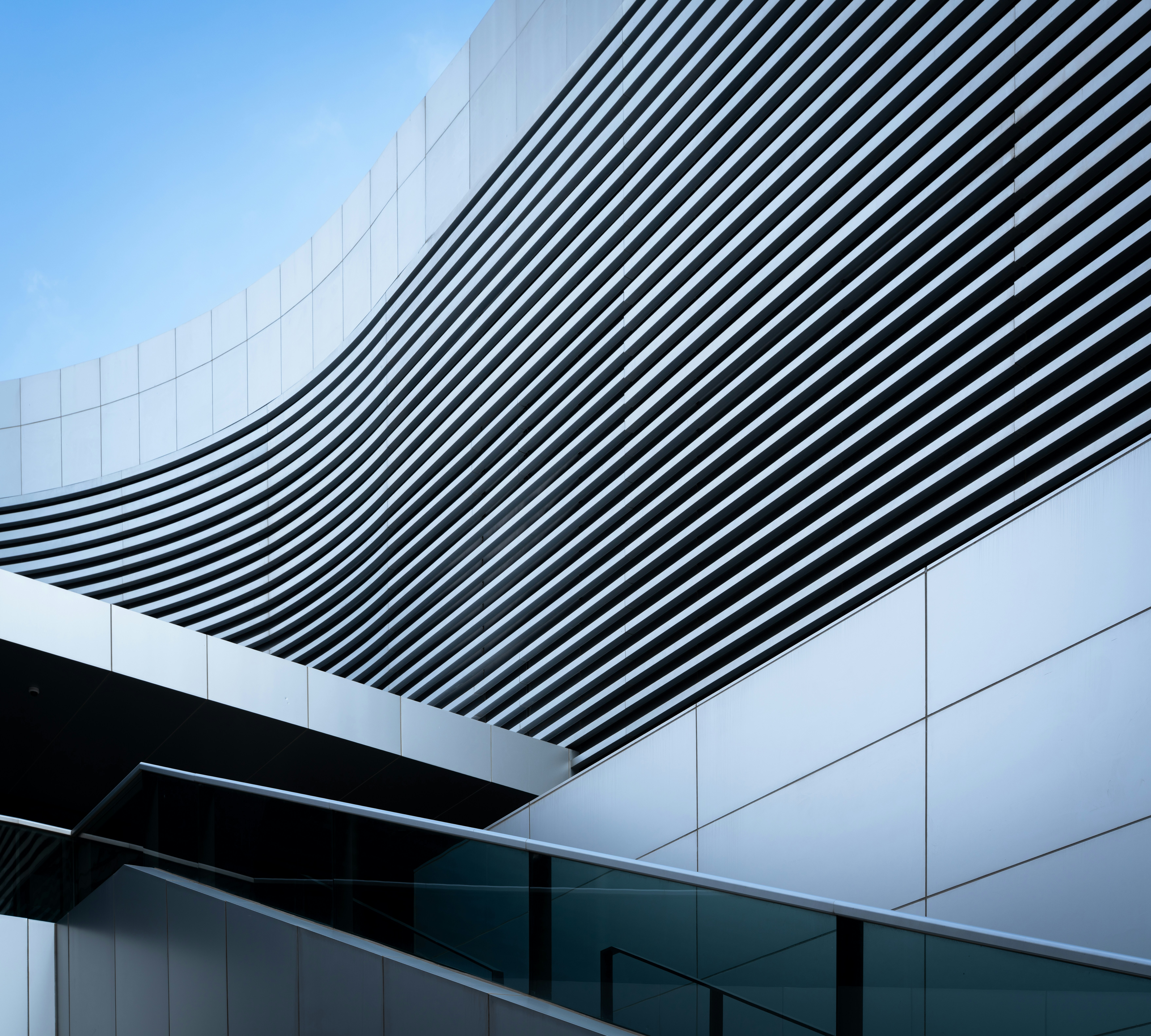Modern architectural lines and curves against blue sky photo – Free ...