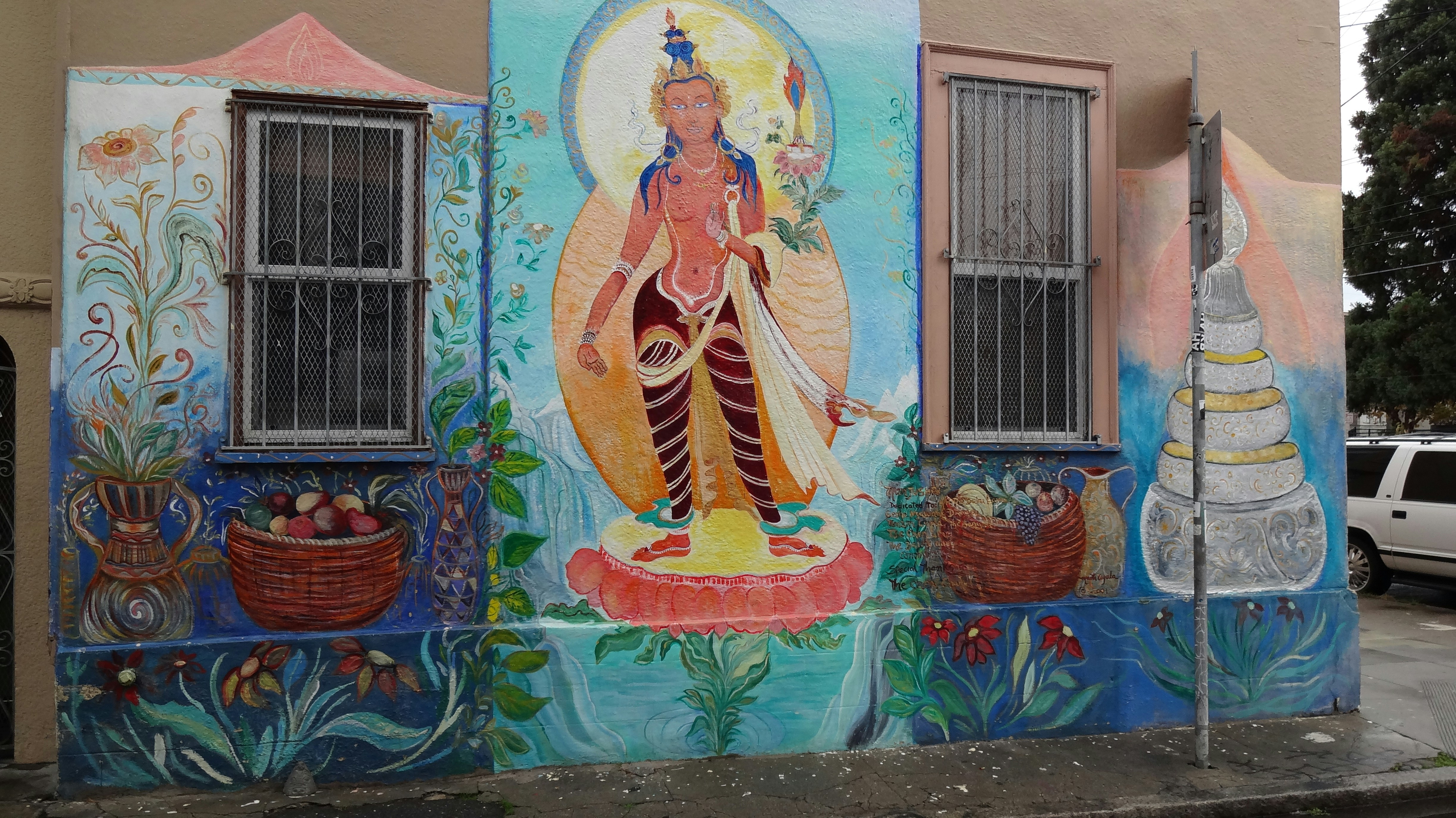 Colorful mural with deity and floral motifs