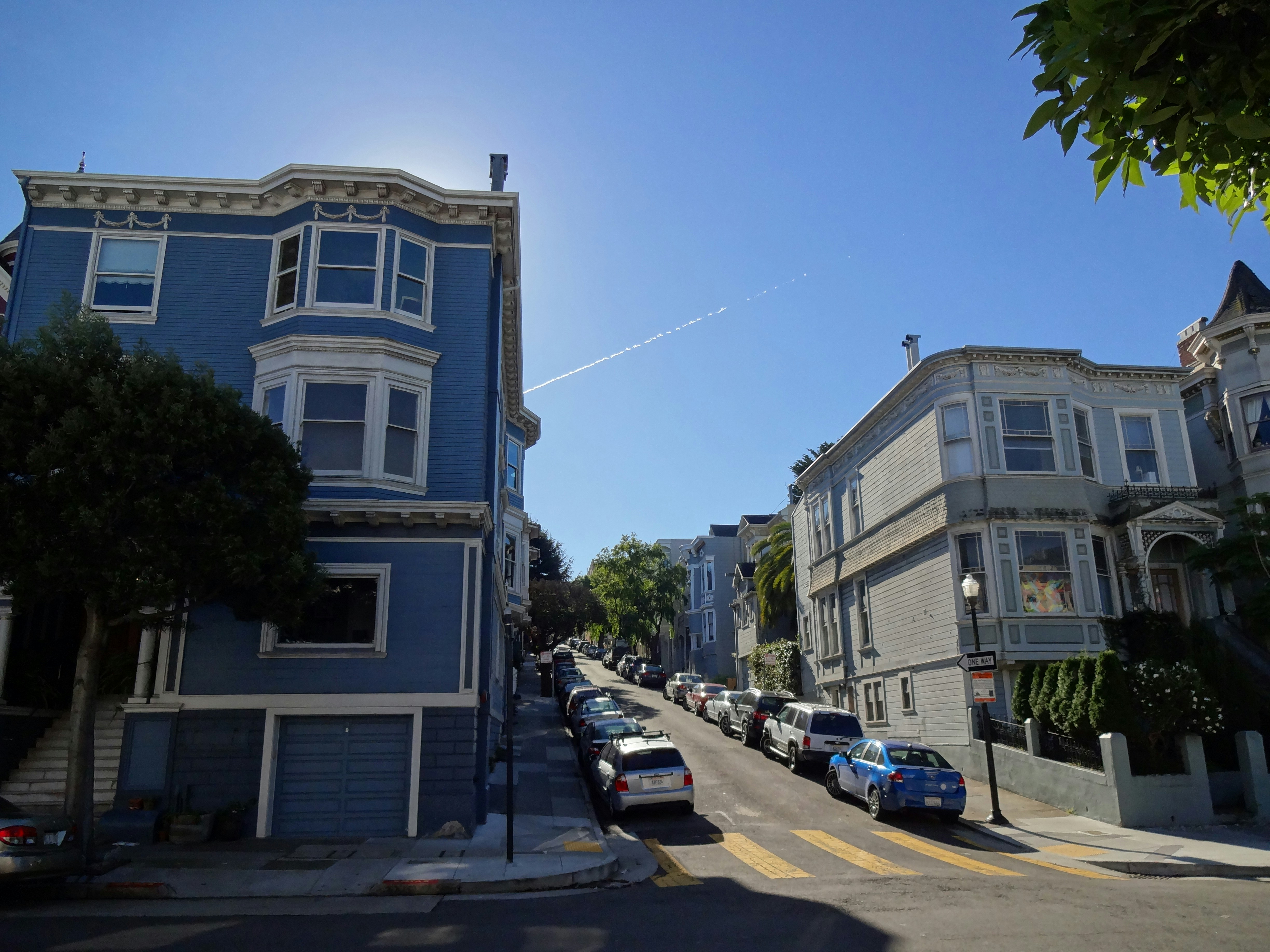 Blue and grey houses on a steep san francisco street.