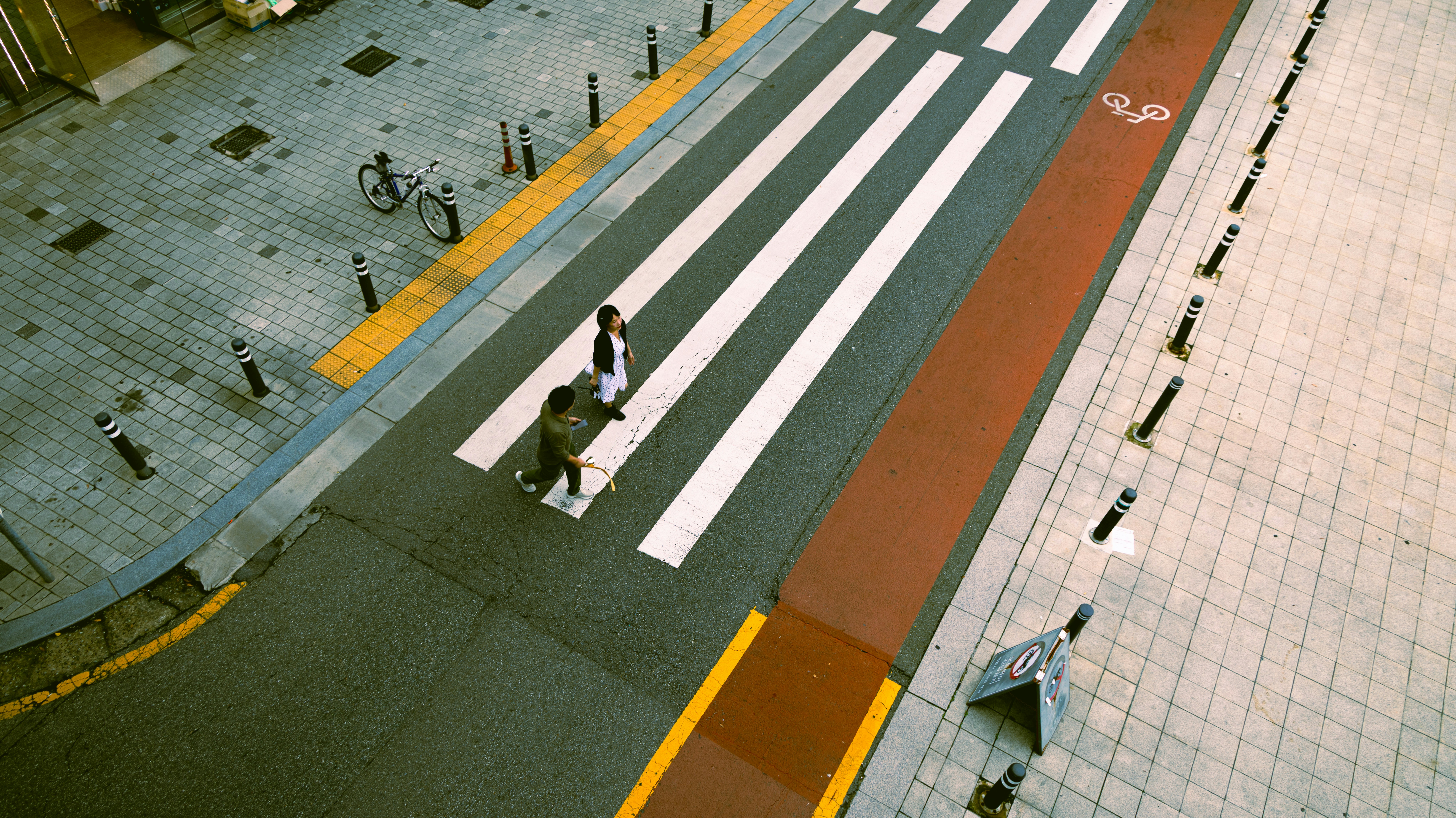 Two people crossing a crosswalk on a city street. photo – Free City ...
