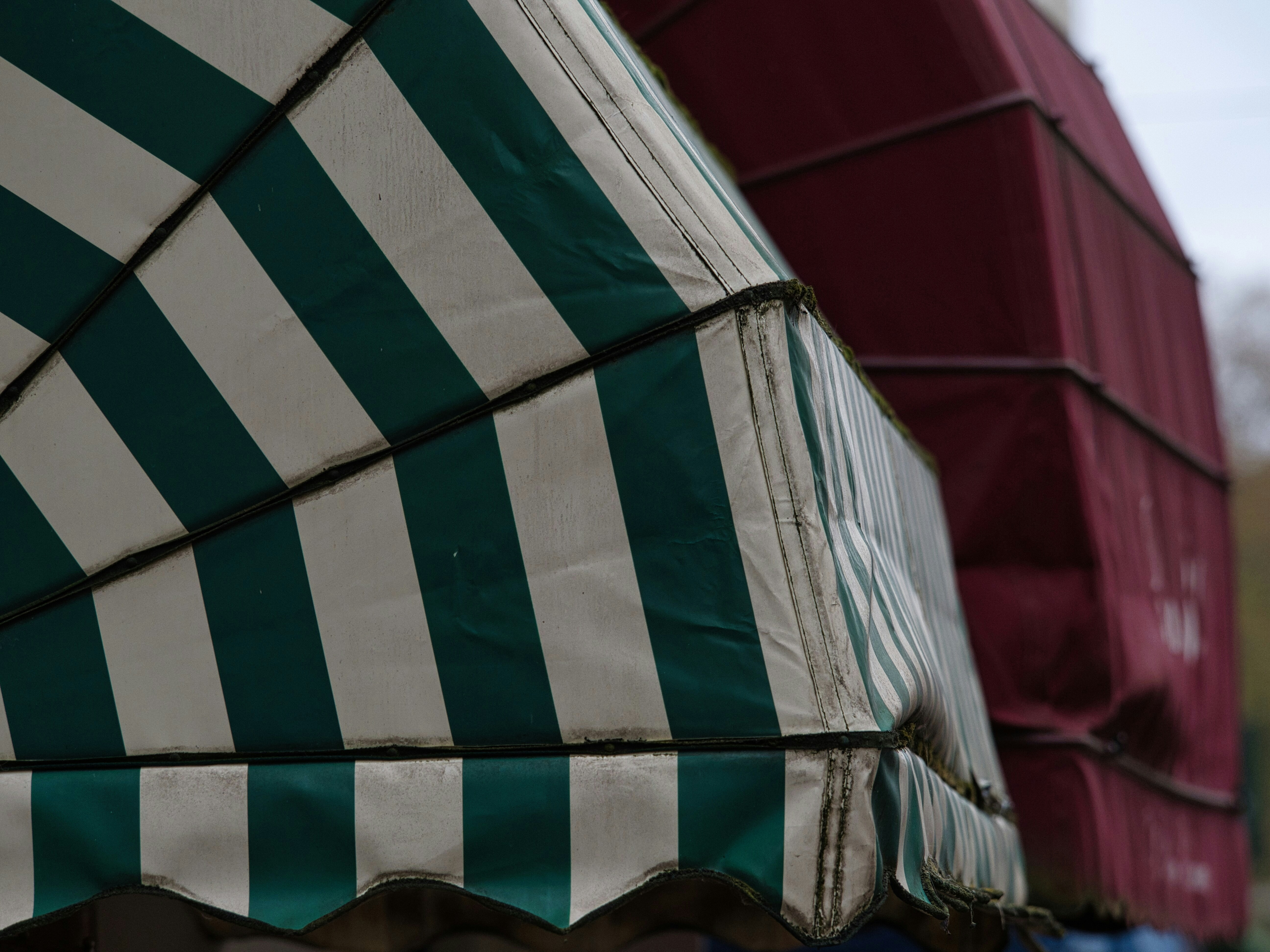 Close-up of striped canopies in contrasting colors, showcasing their unique textures and patterns. The image highlights the interplay of light and shadow.