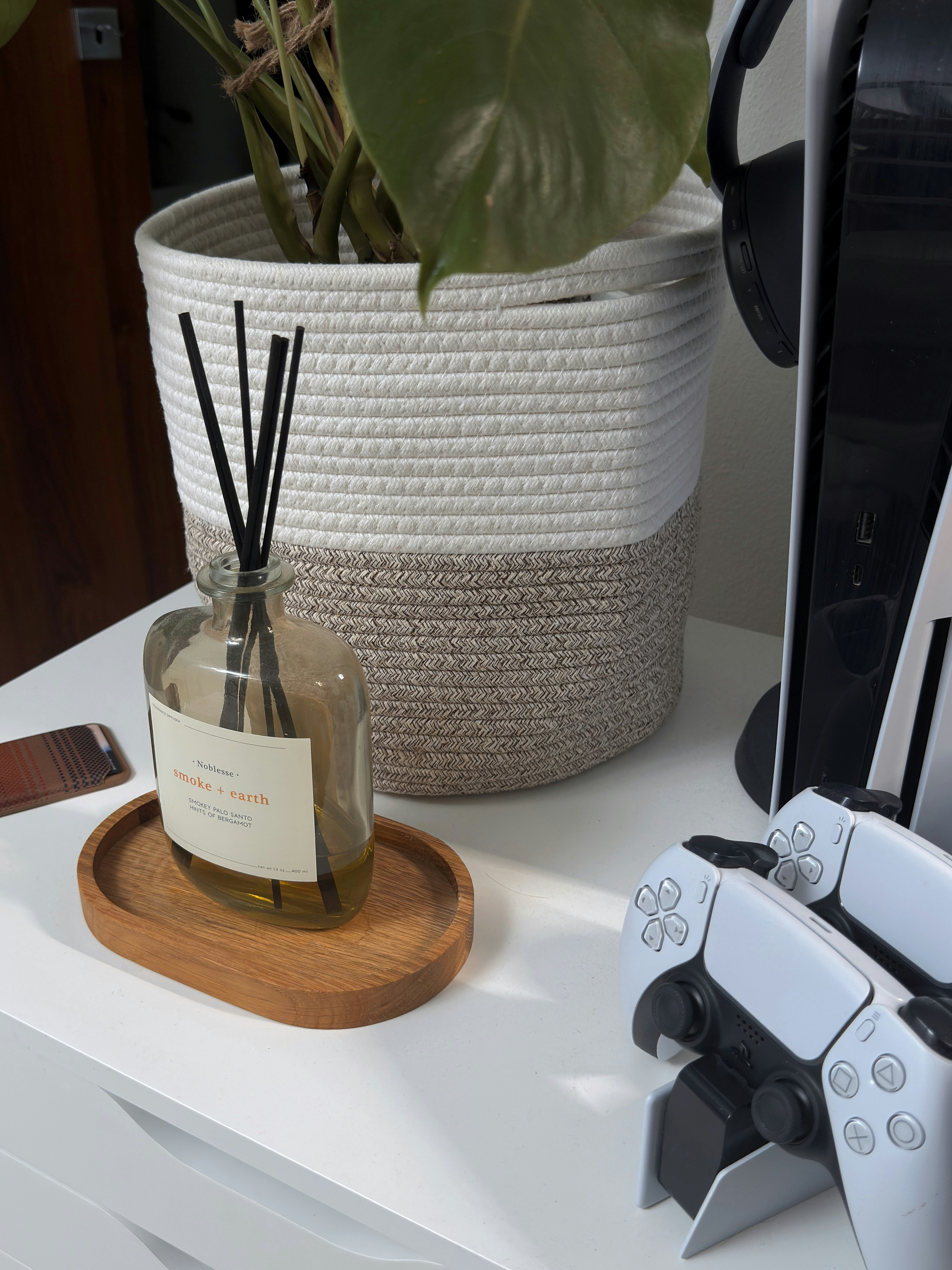 Reed diffuser on wooden tray next to game controllers. photo – Free ...