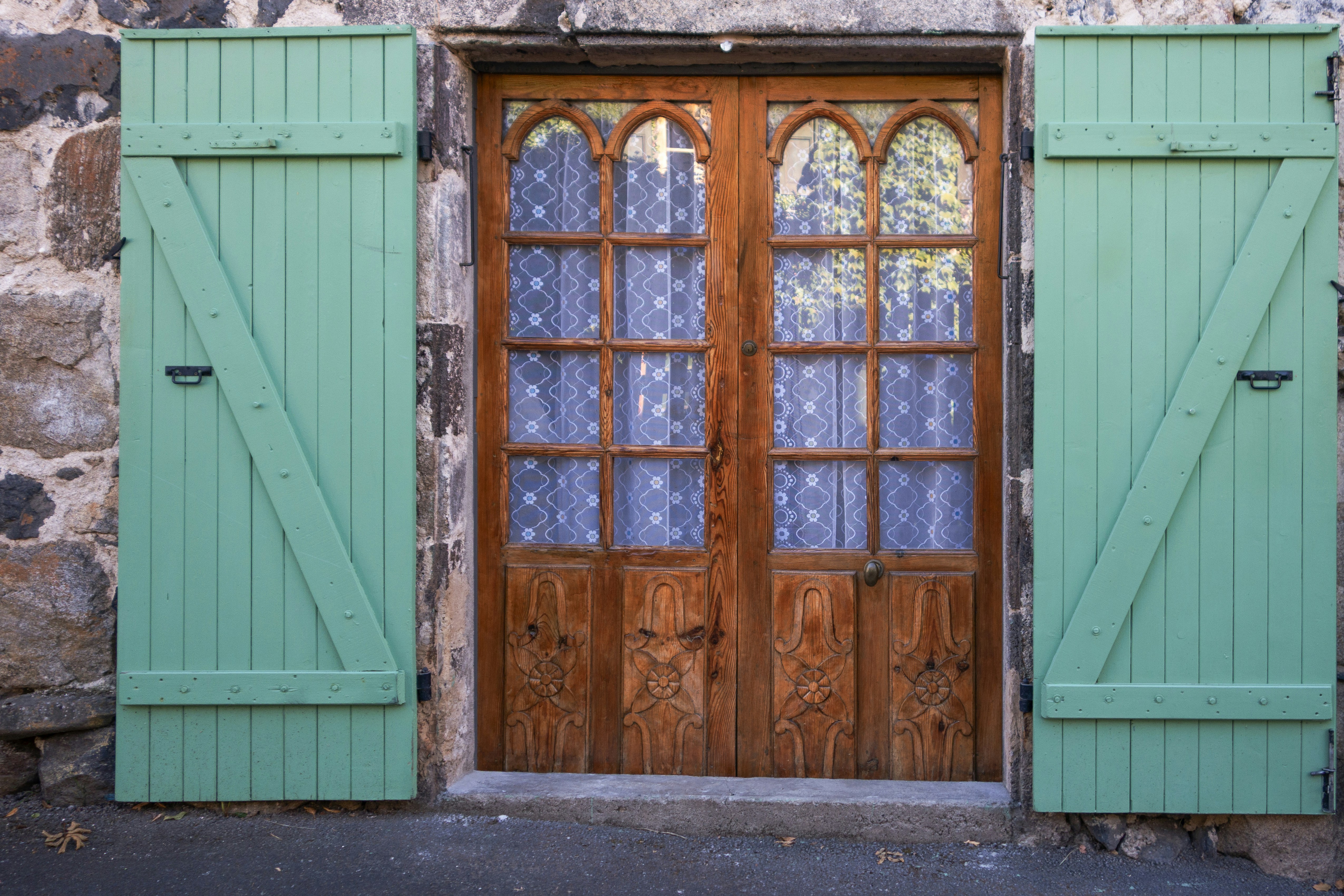 Wooden doors with arched windows and green shutters photo – Free ...