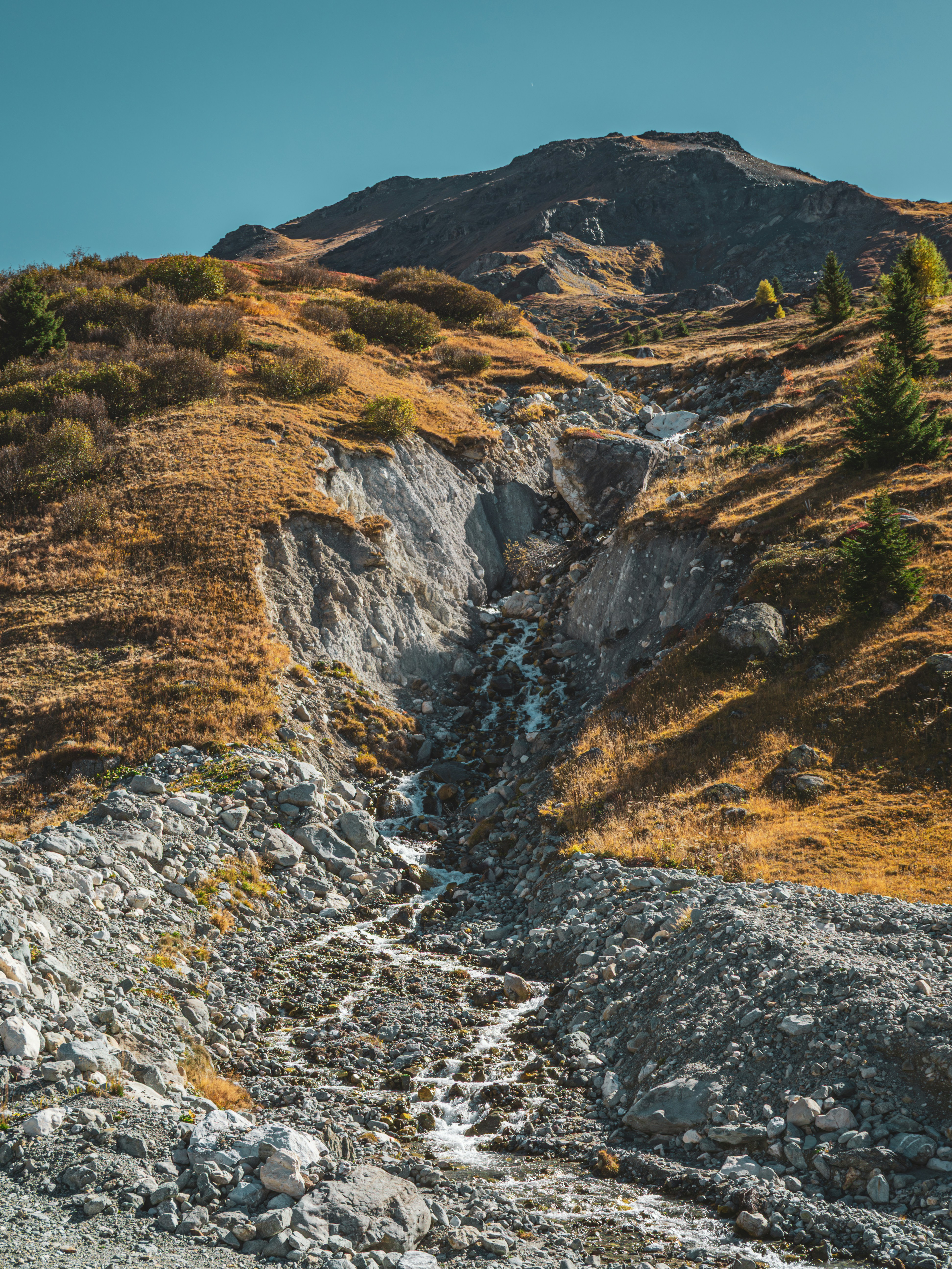 Alpine Stone Gully Winding Up Toward a Rocky Summit