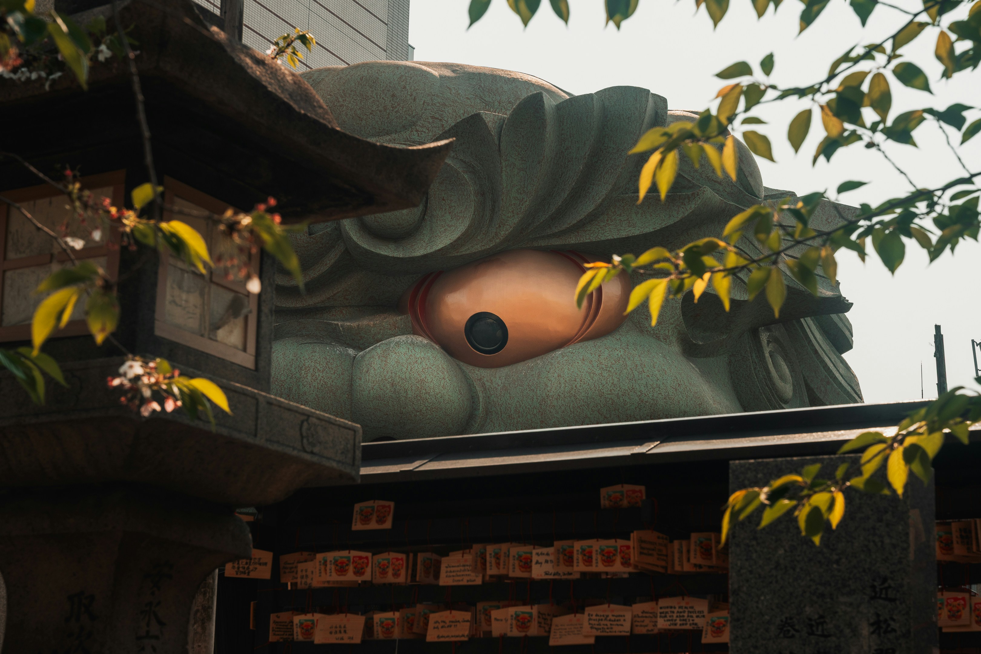 Check out my instagram - @sebastiandugudae | Giant stone owl statue peeking through branches