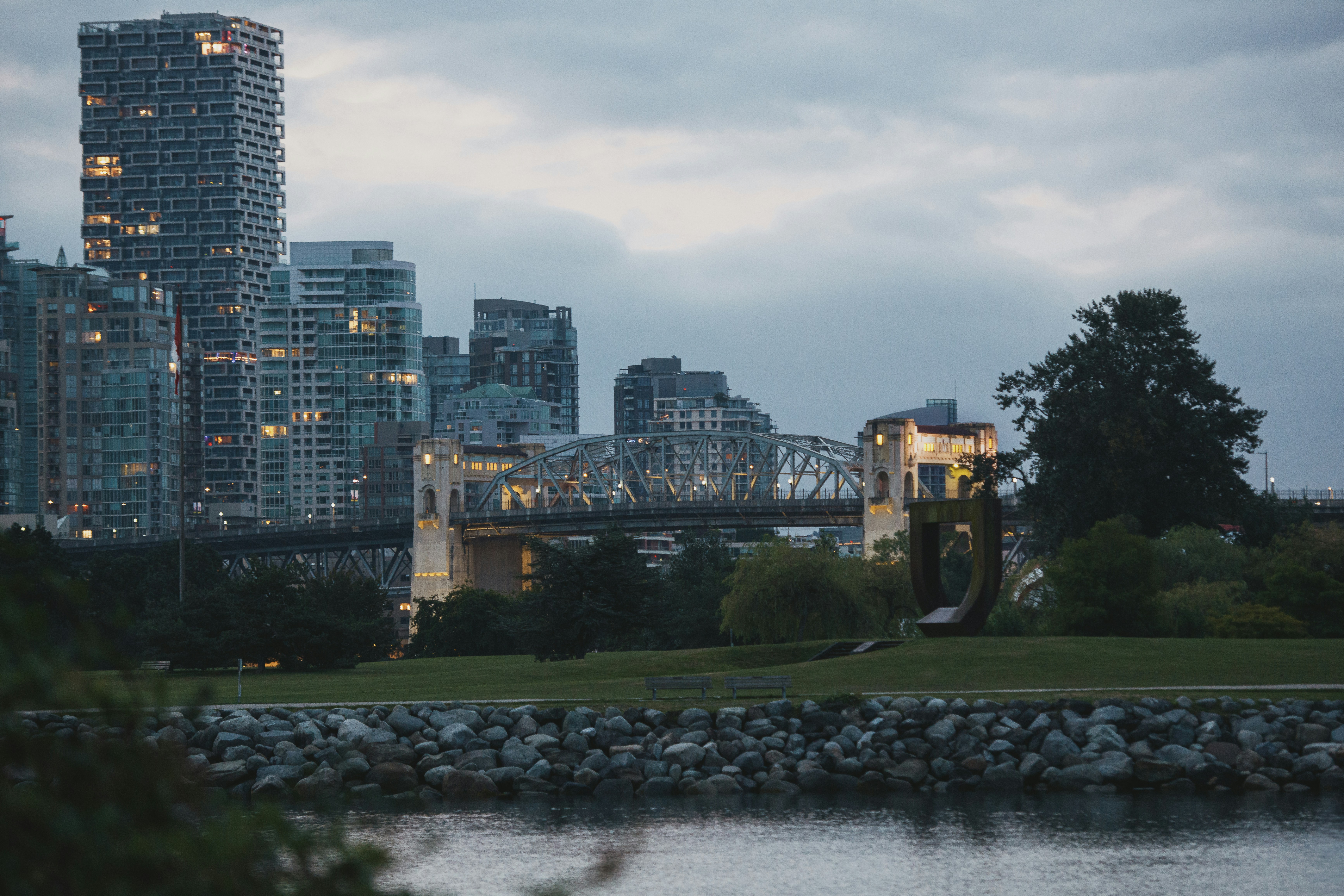Burrard bridge during sunrise | City skyline with bridge and park at dusk