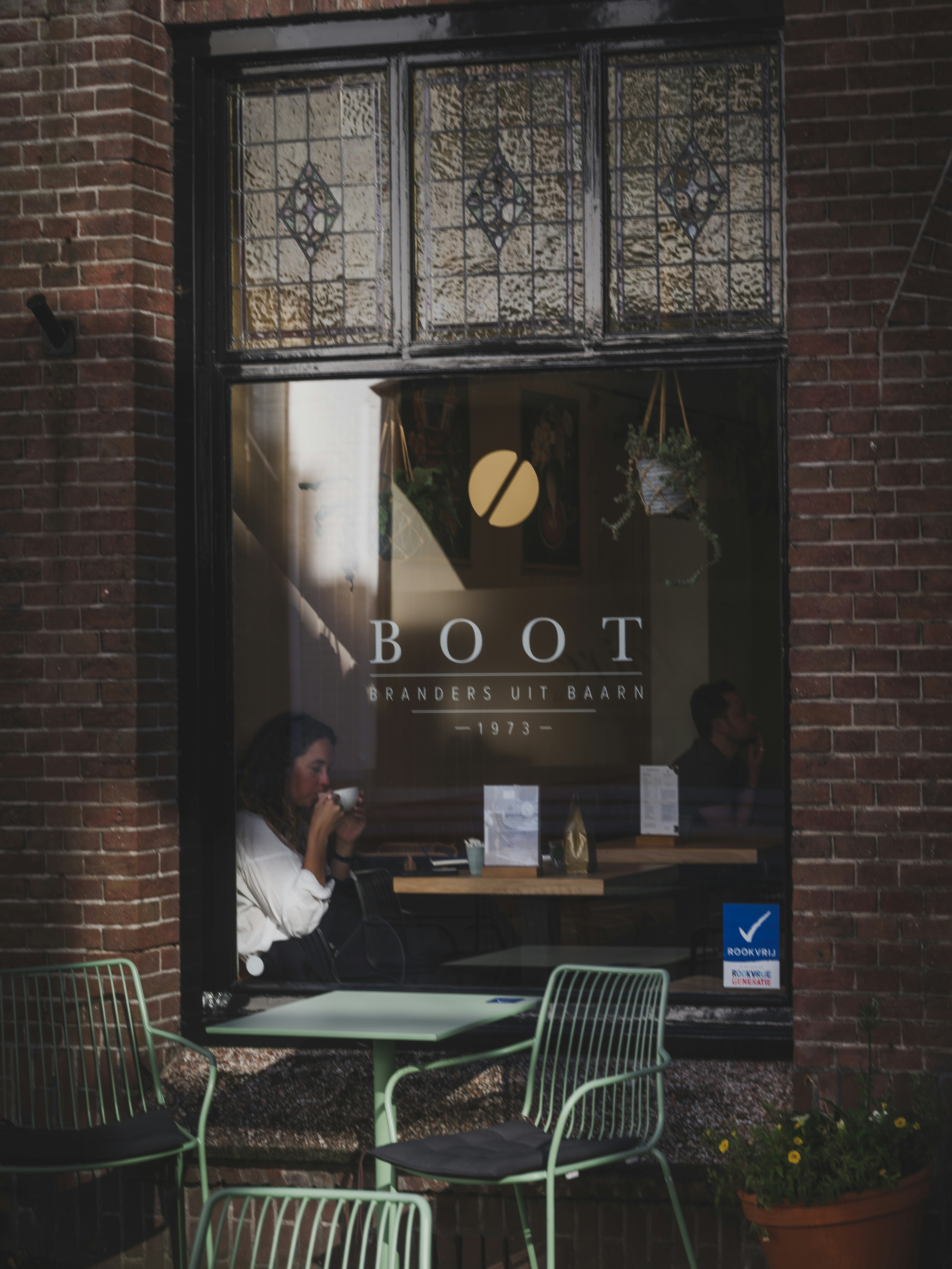 Boot Café Window at Dusk: Quiet Moments Behind Brick and Glass