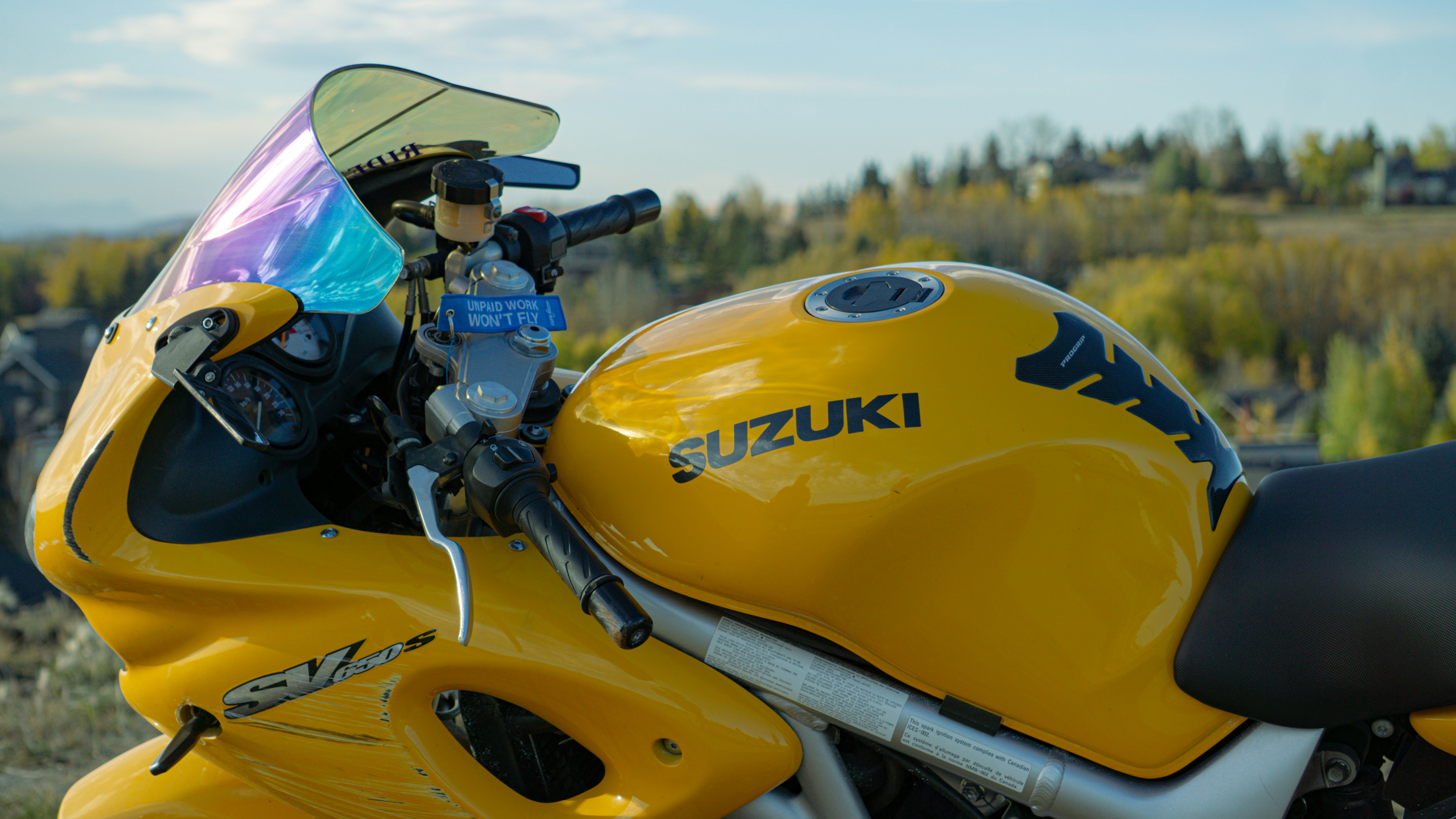 Yellow suzuki motorcycle with a scenic background