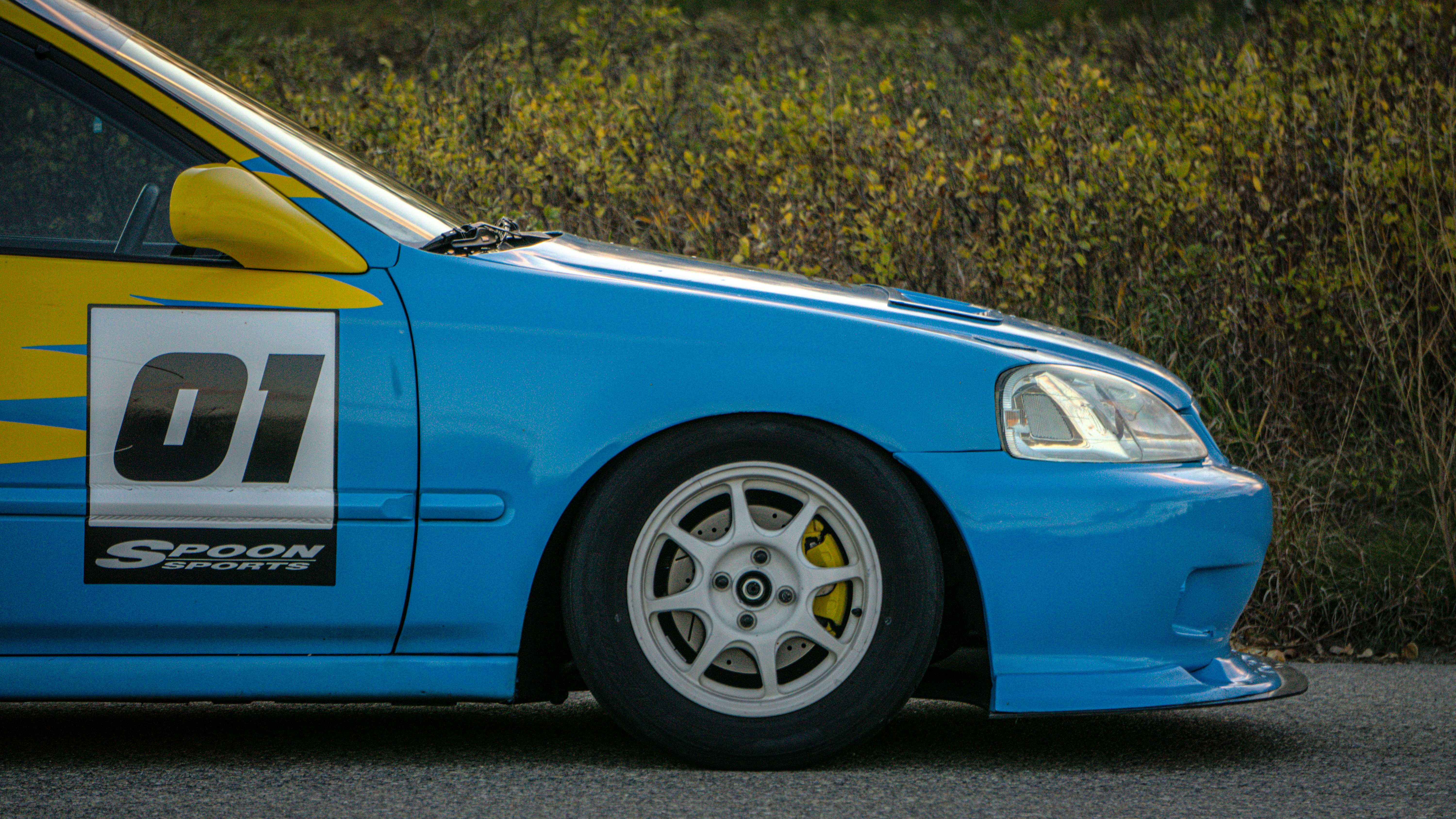 Blue and yellow race car with number 01.