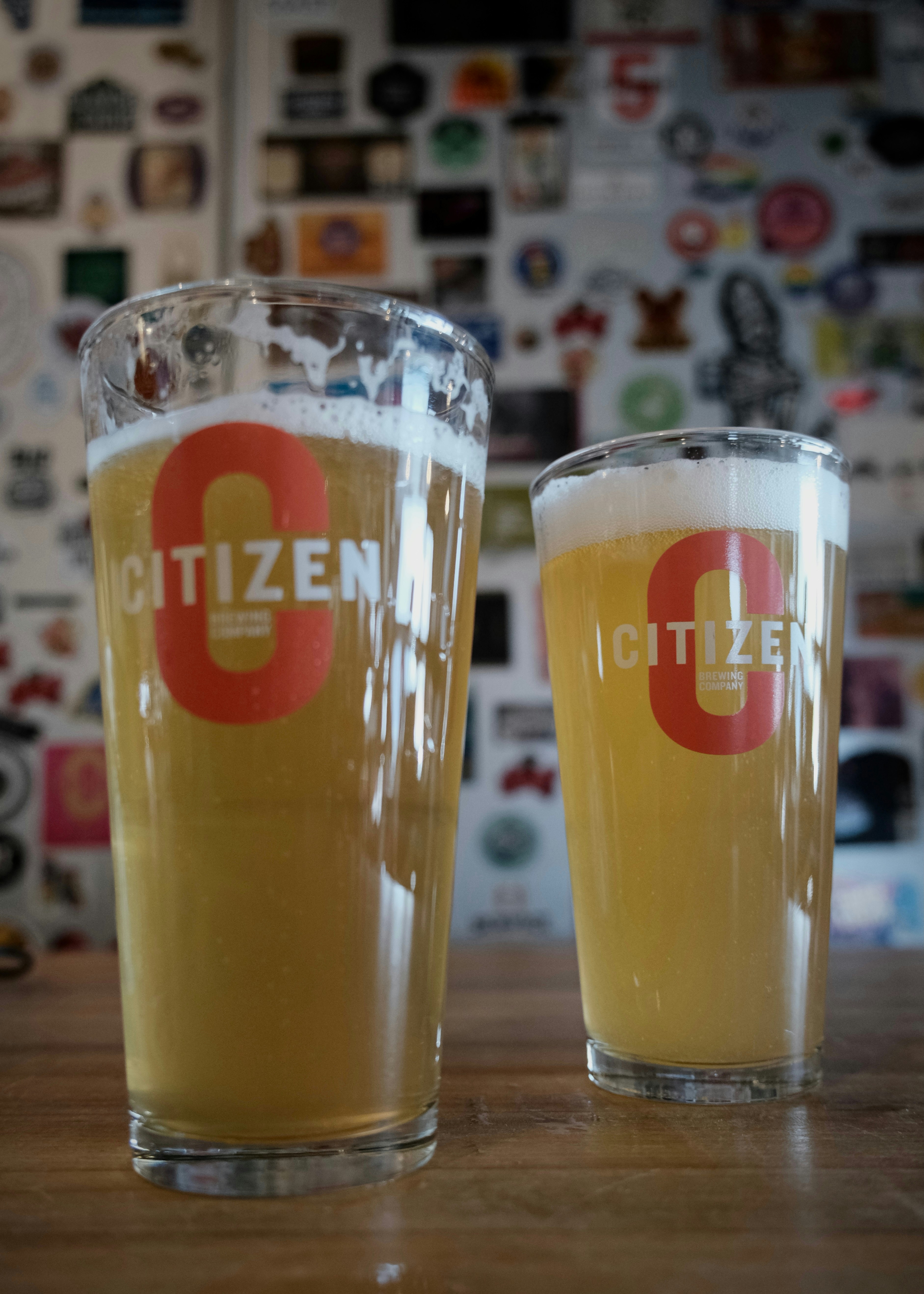 Two glasses of beer with logo on table