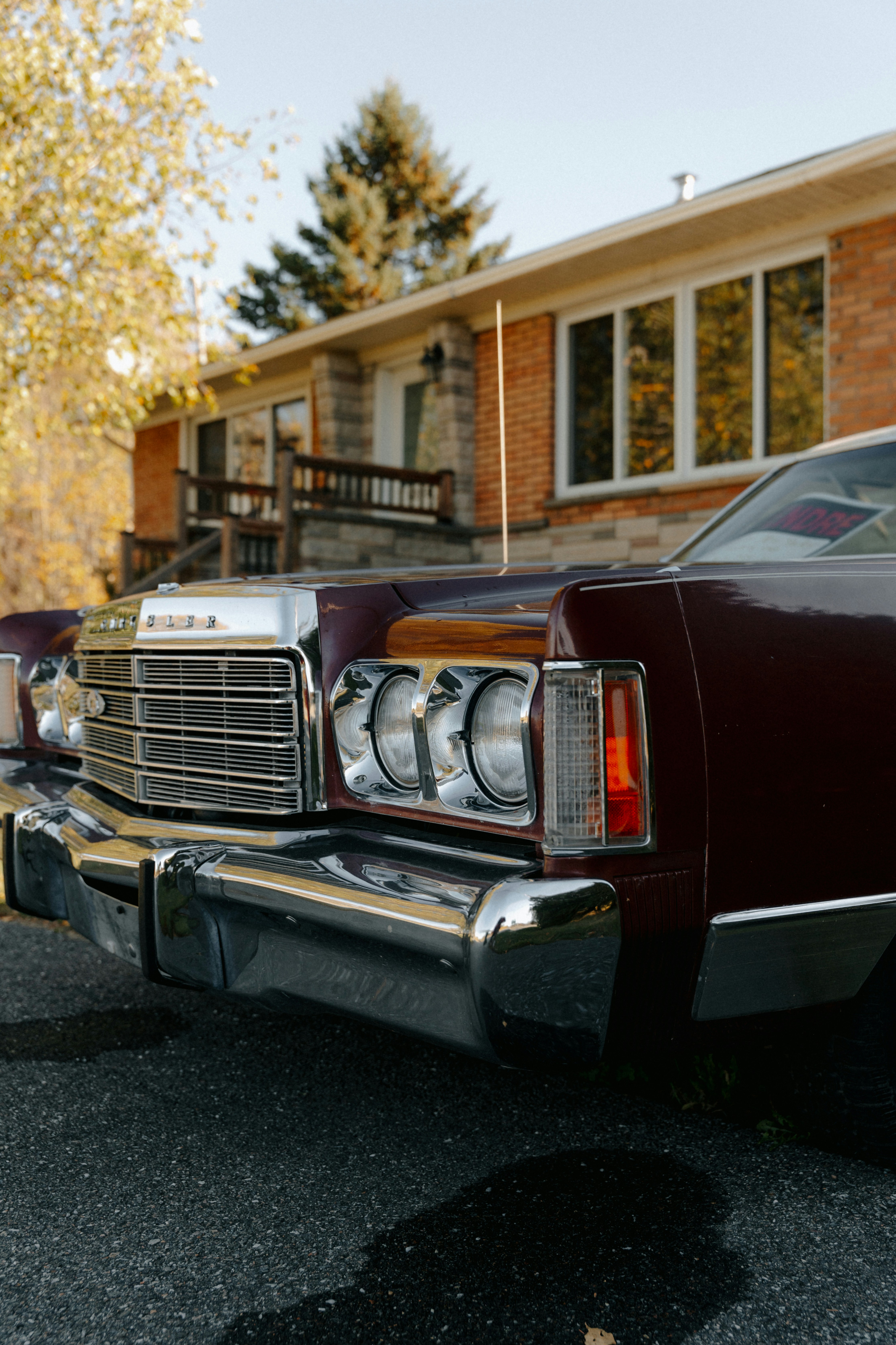 Maroon Chrome: Sunlit Front End of a Vintage Cadillac