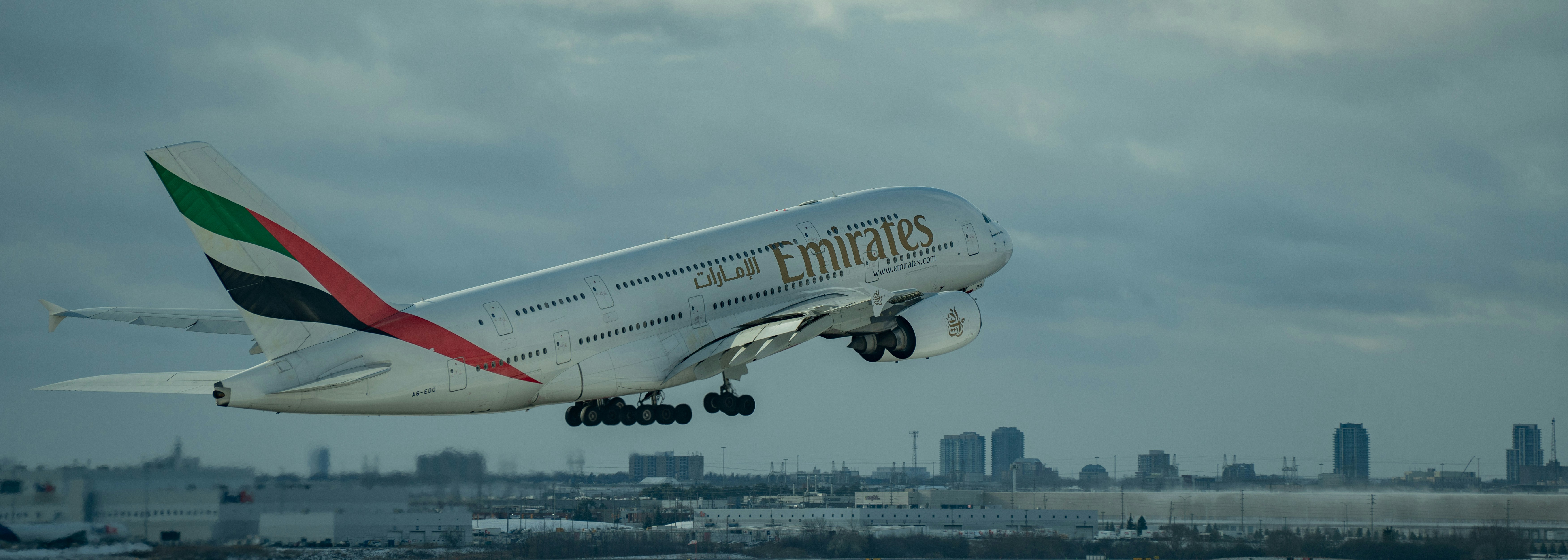 Airbus A380 | Emirates airplane taking off over city skyline